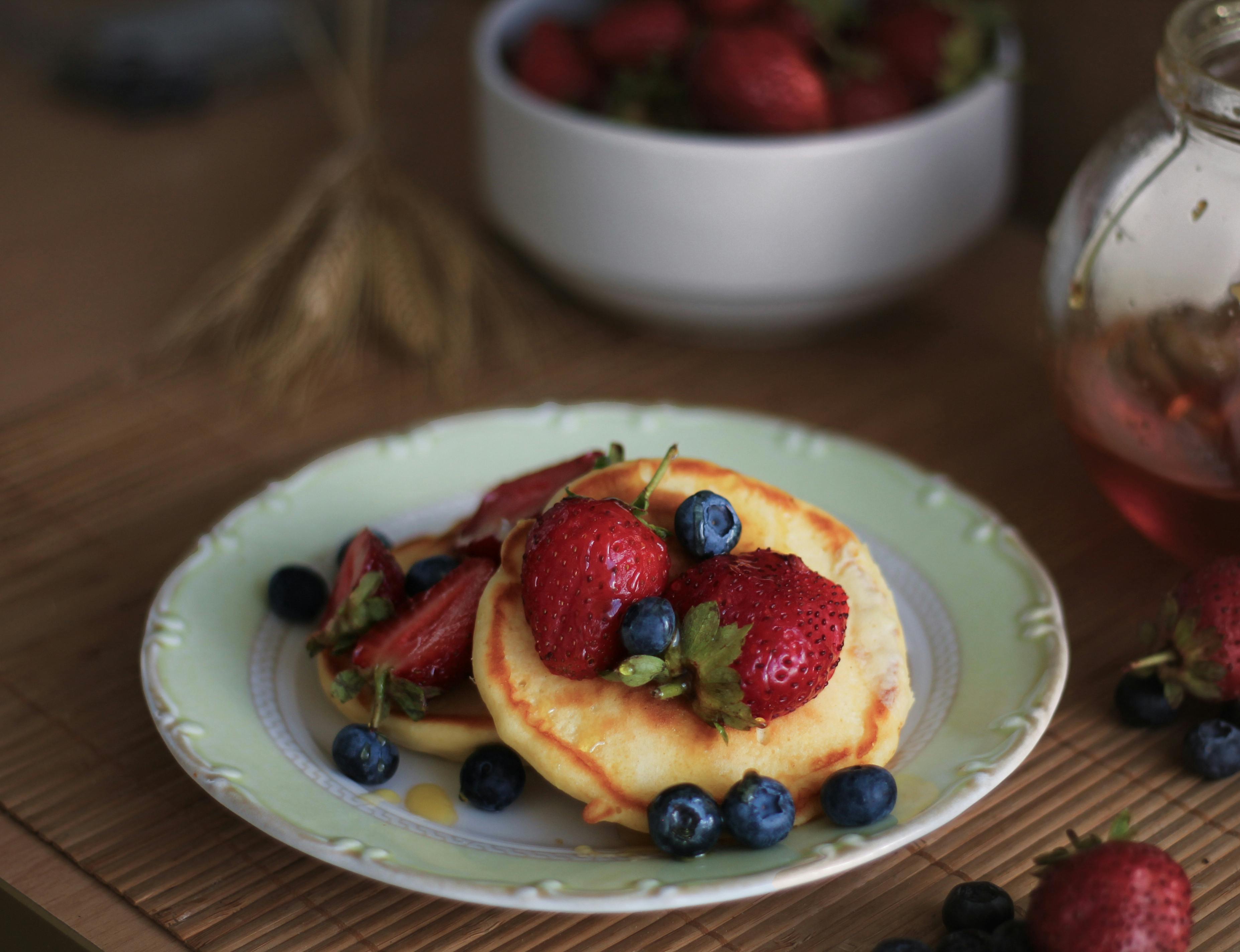 Pancakes with berries and honey on a plate · Free Stock Photo