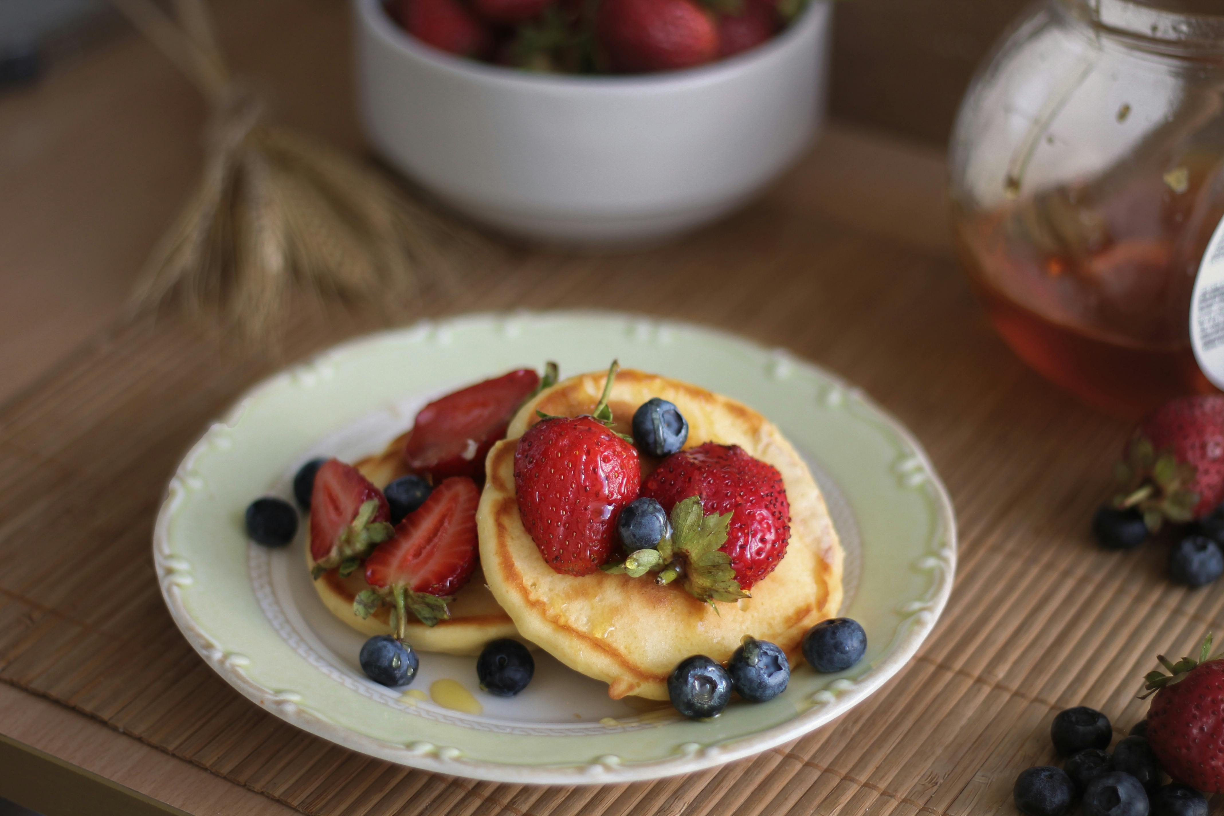 Pancakes with berries and honey on a plate · Free Stock Photo