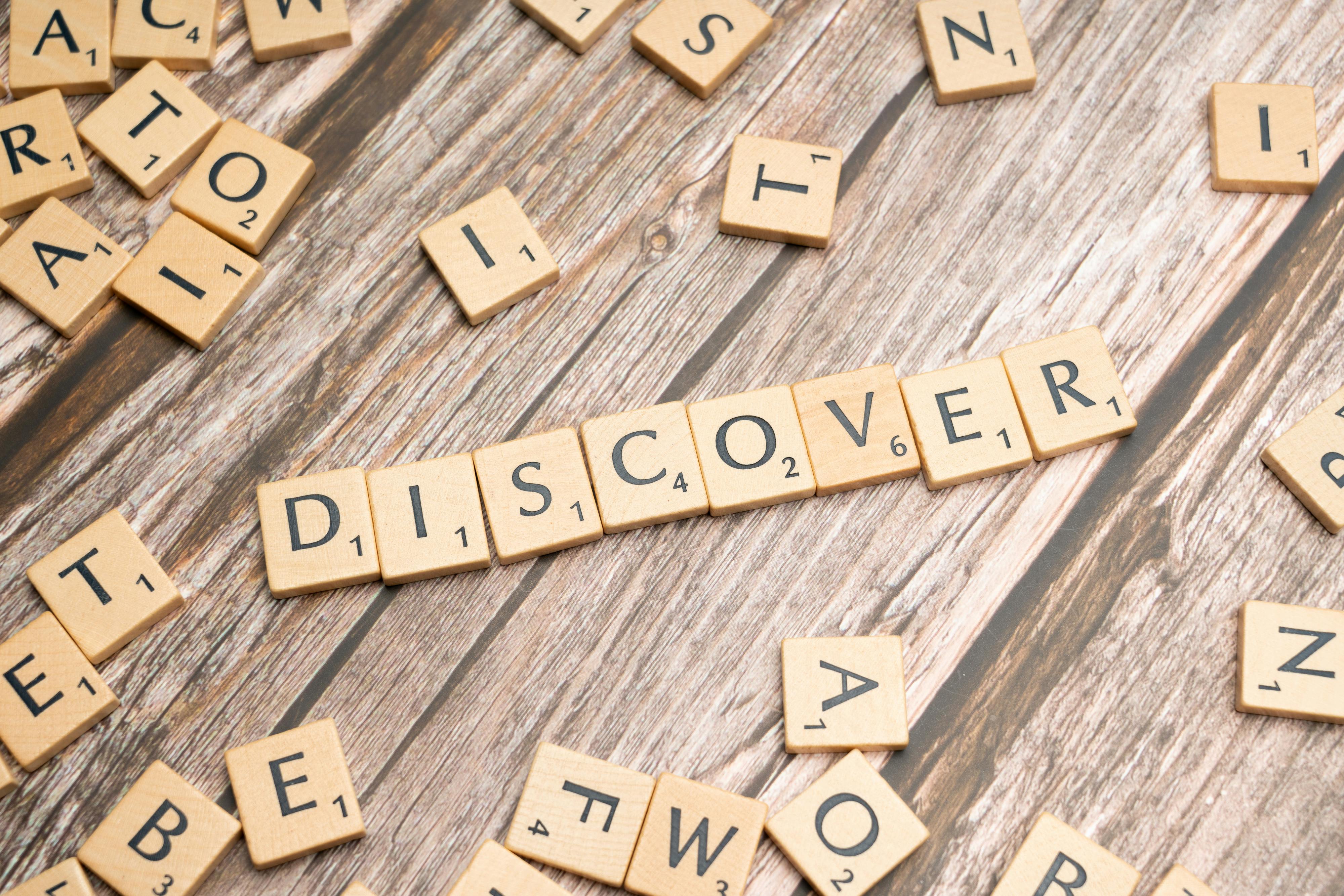 The word discover spelled out in scrabble letters · Free Stock Photo