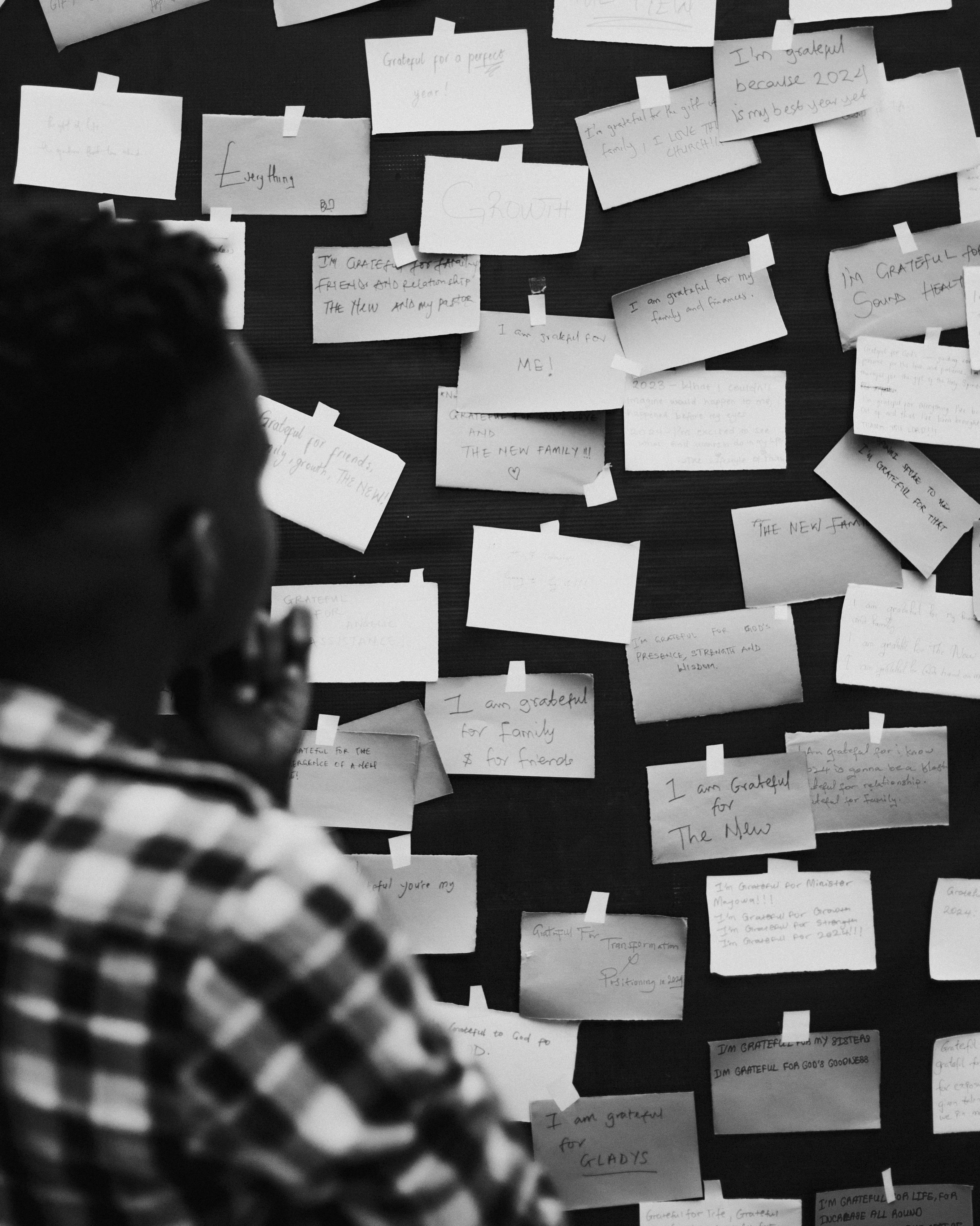 Man Looking at Sticky Notes in Black and White · Free Stock Photo