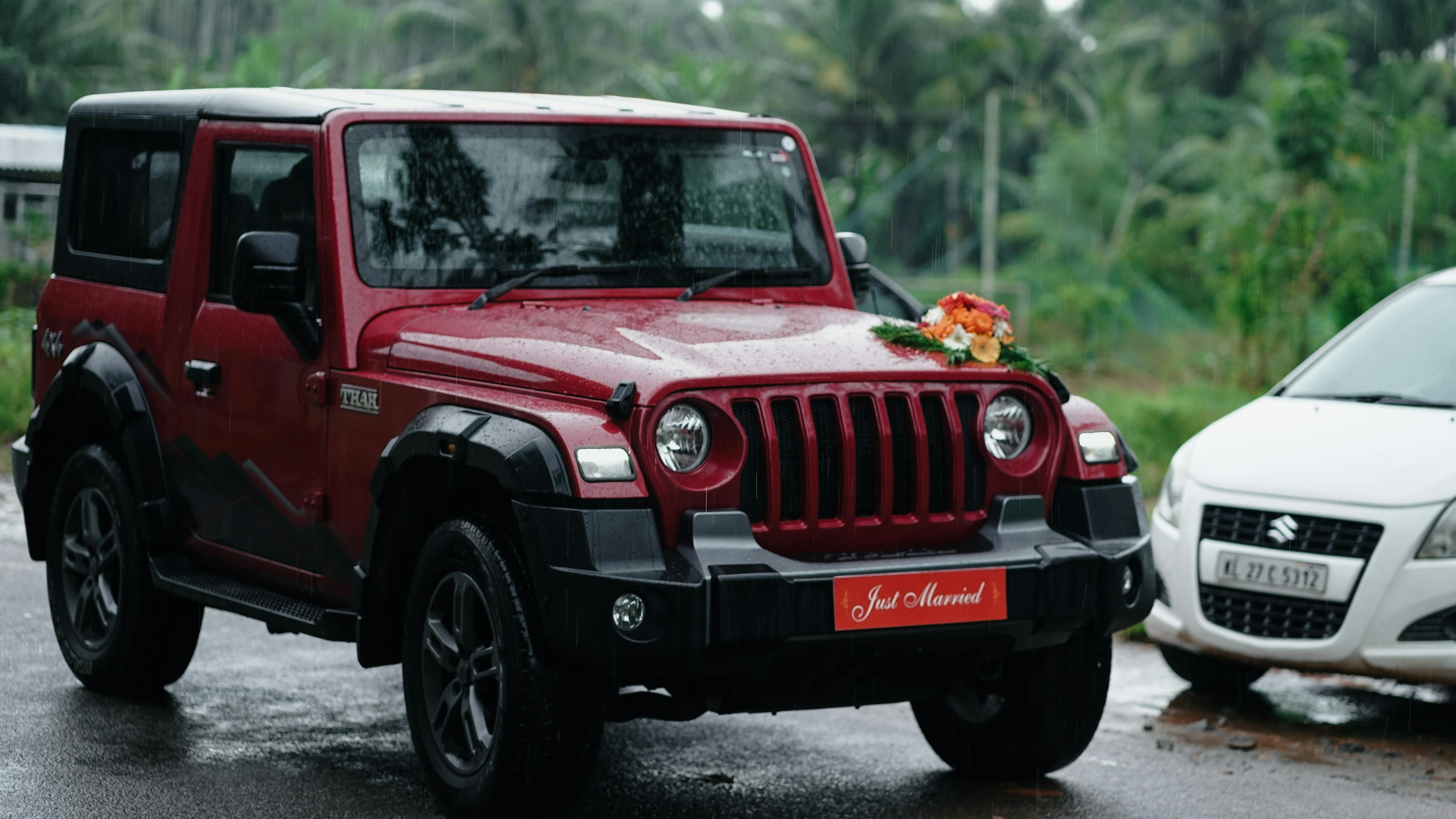 Red and White Cars on a Parking Lot in a Forest · Free Stock Photo