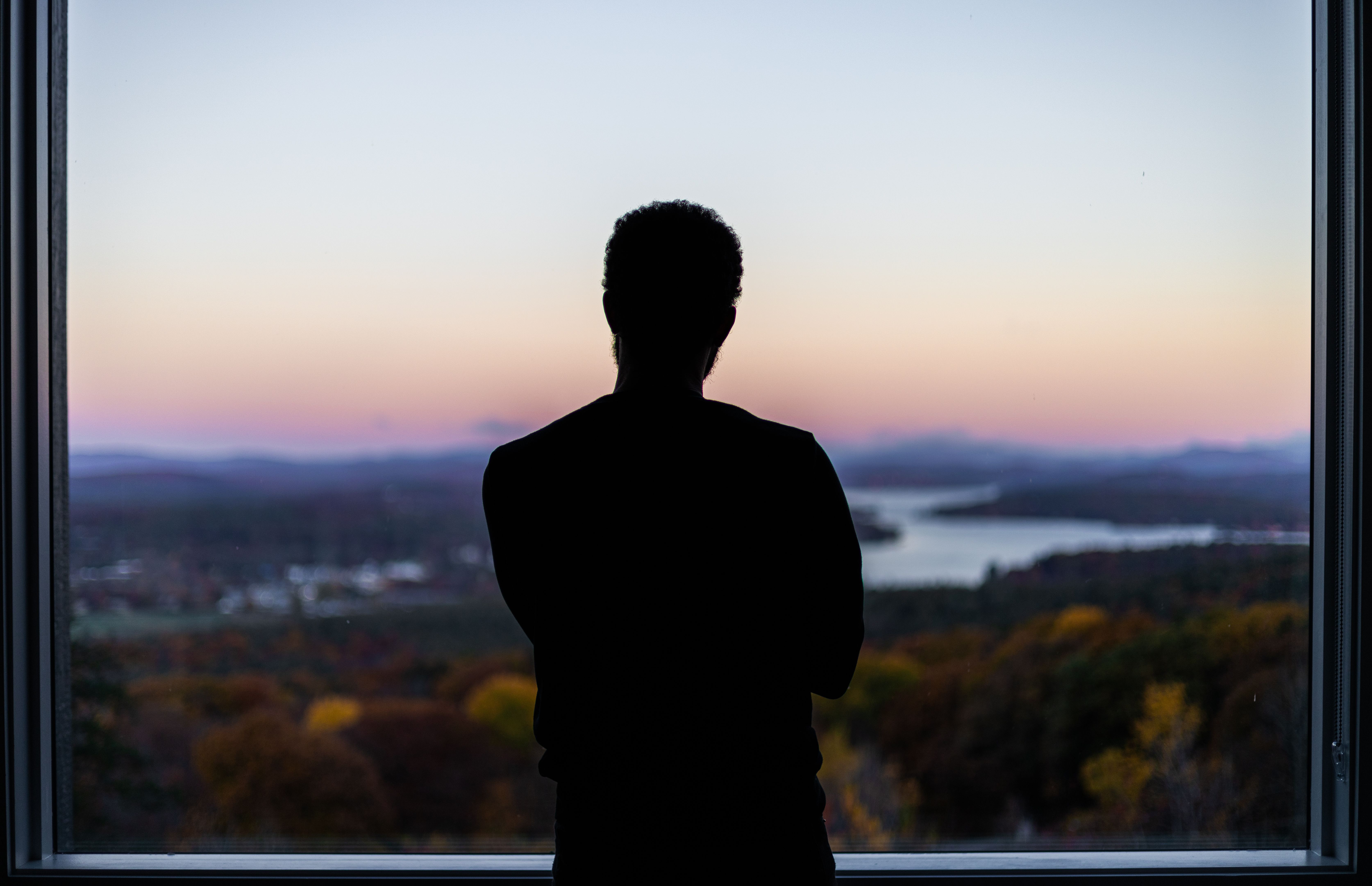 Silhouette of a Person Looking Through a Window at a Sunset · Free ...
