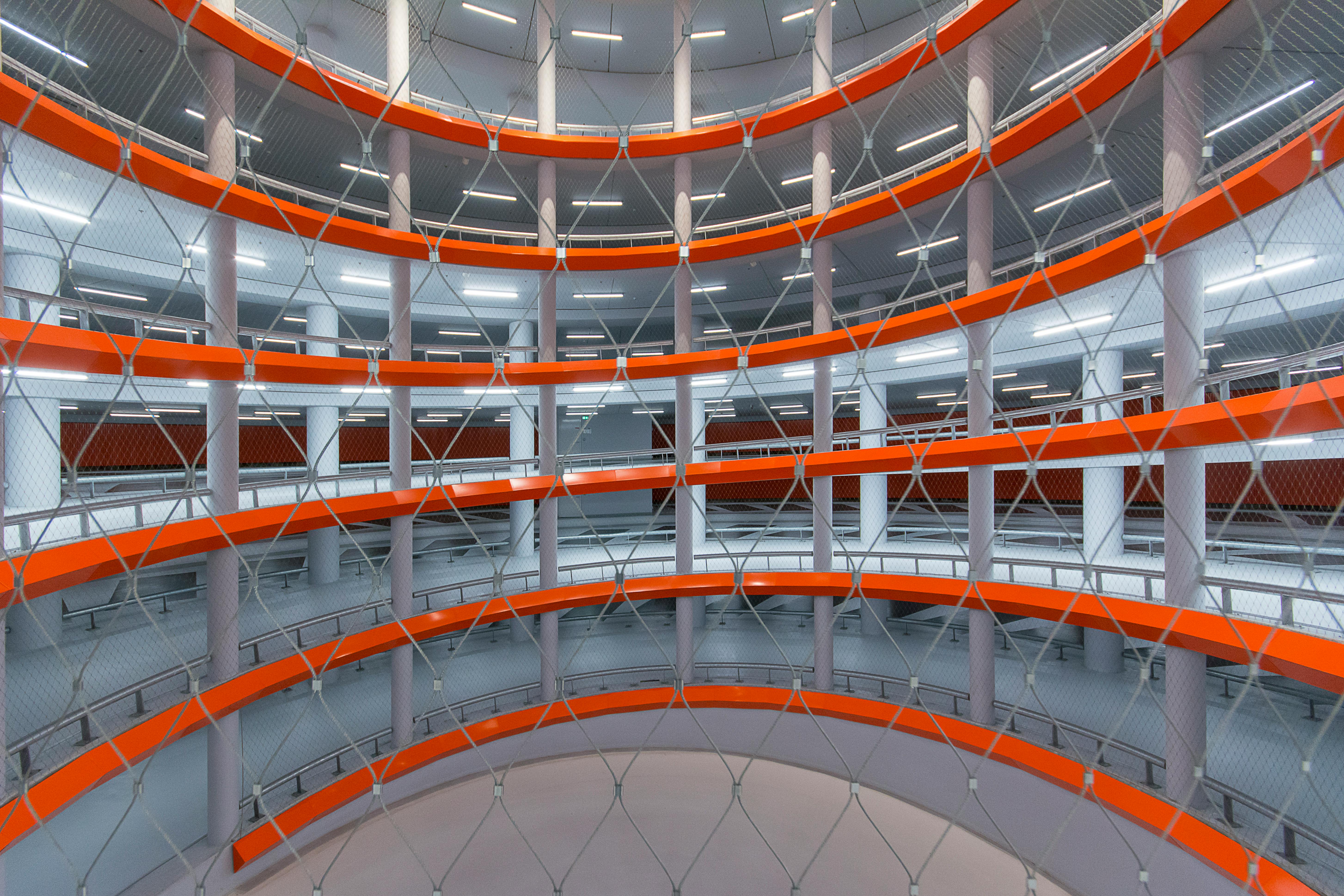 A circular building with orange and white stripes · Free Stock Photo
