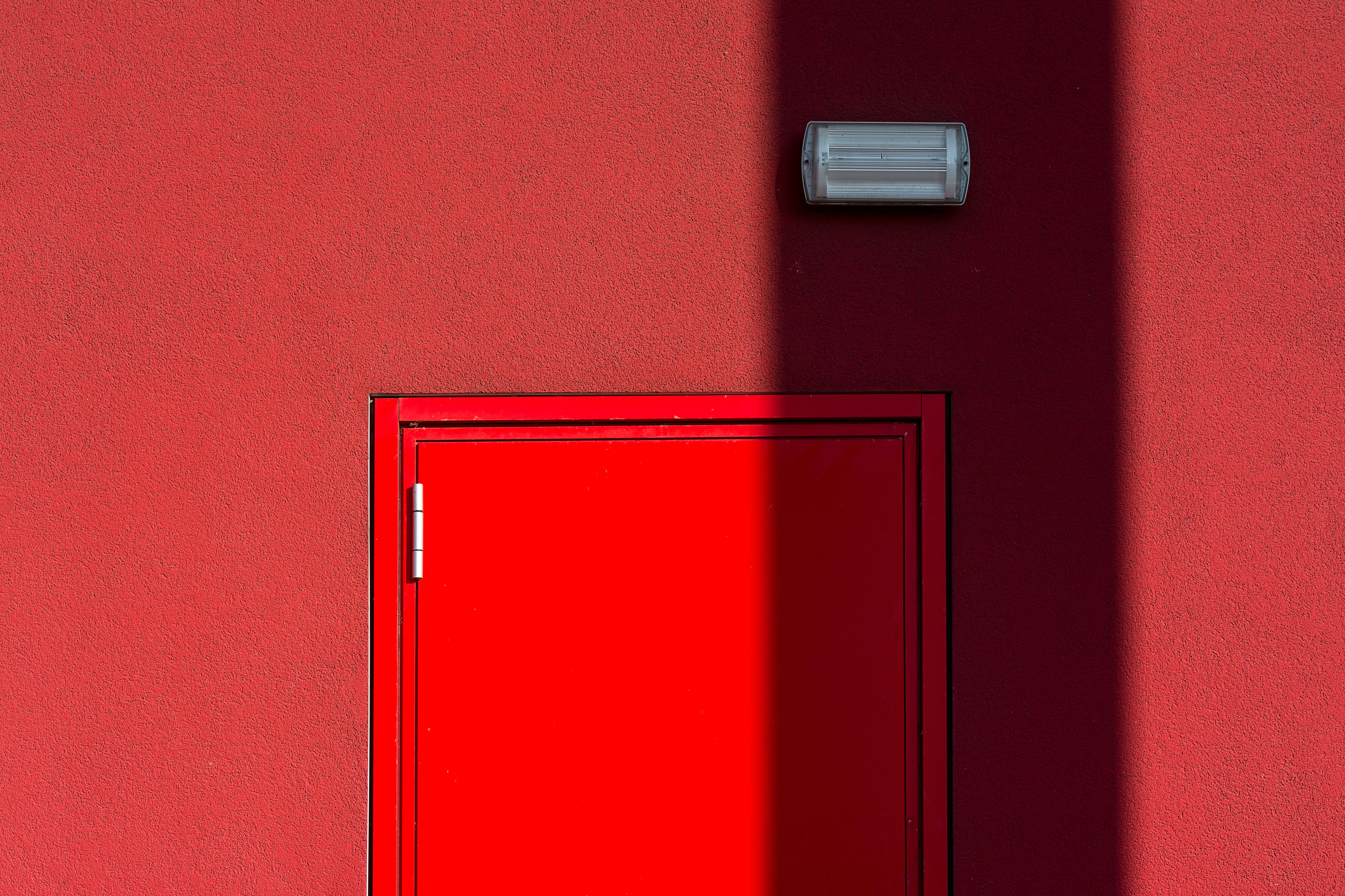Red Exterior and Red Door in a Building in Sunlight · Free Stock Photo