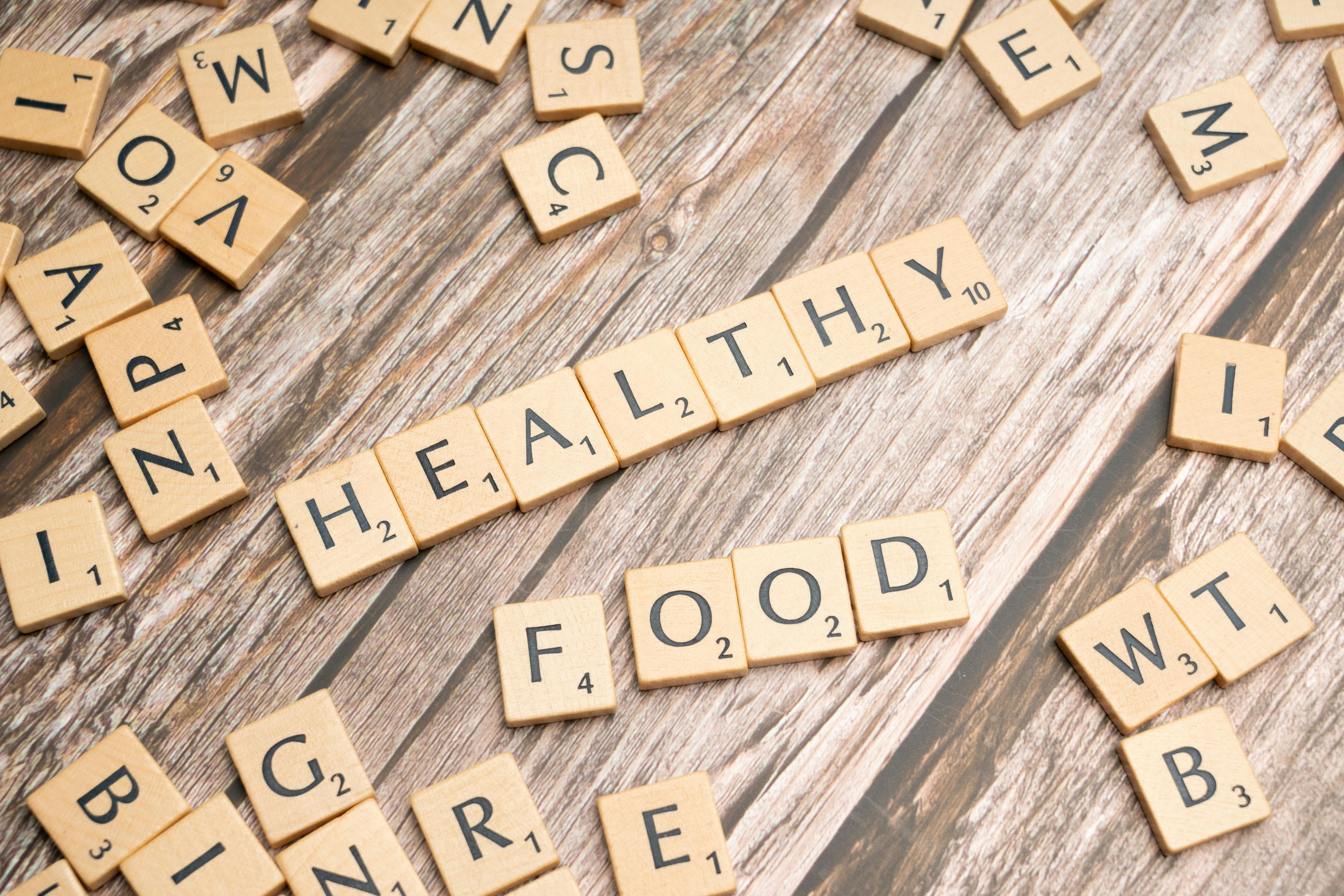 Healthy food on wooden table with scrabble letters · Free Stock Photo