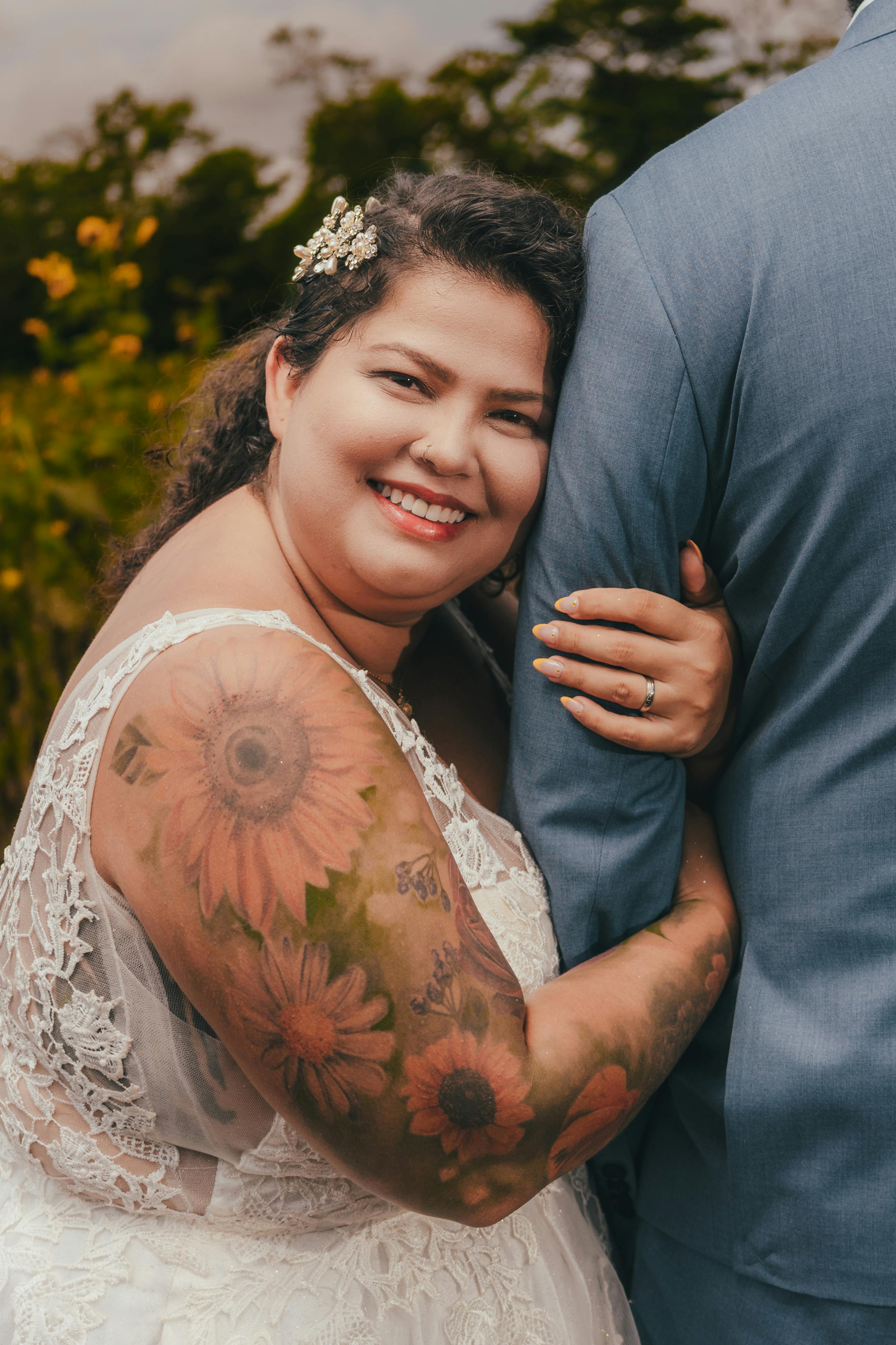 Bride with Tattoos Hugging the Grooms Arm · Free Stock Photo