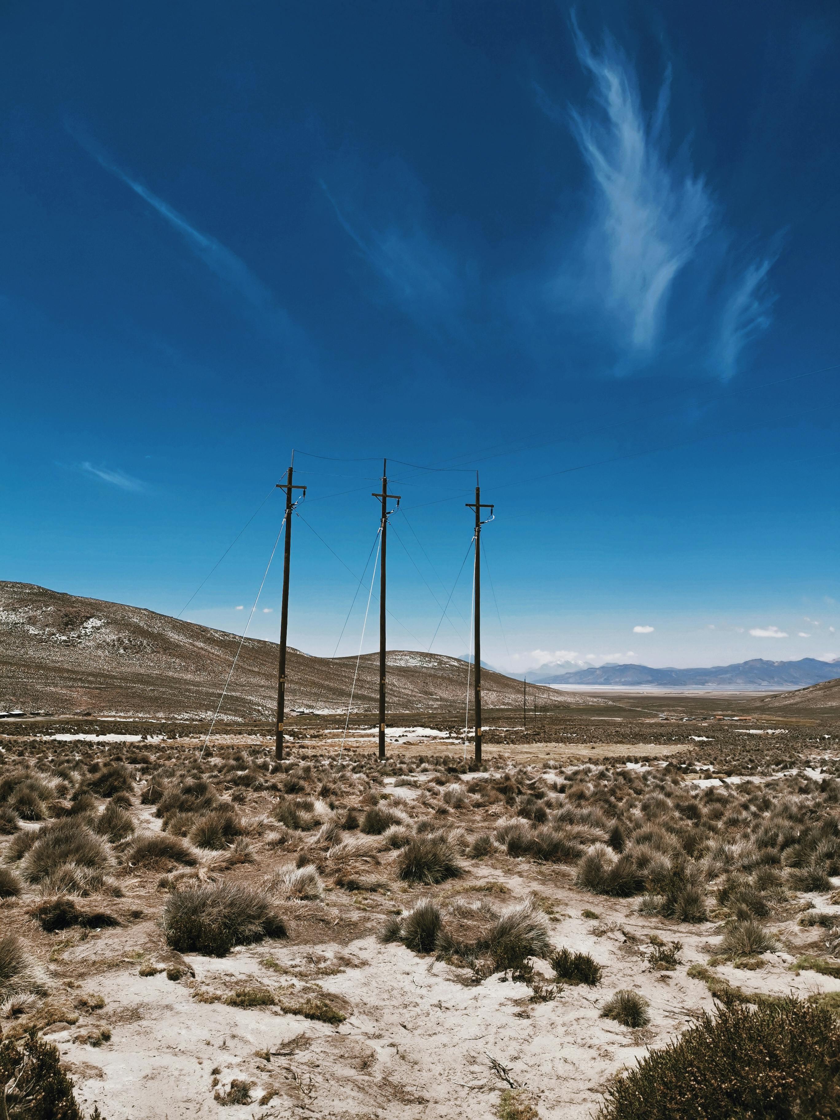 Three Telephone Poles in a Remote Arid Area · Free Stock Photo