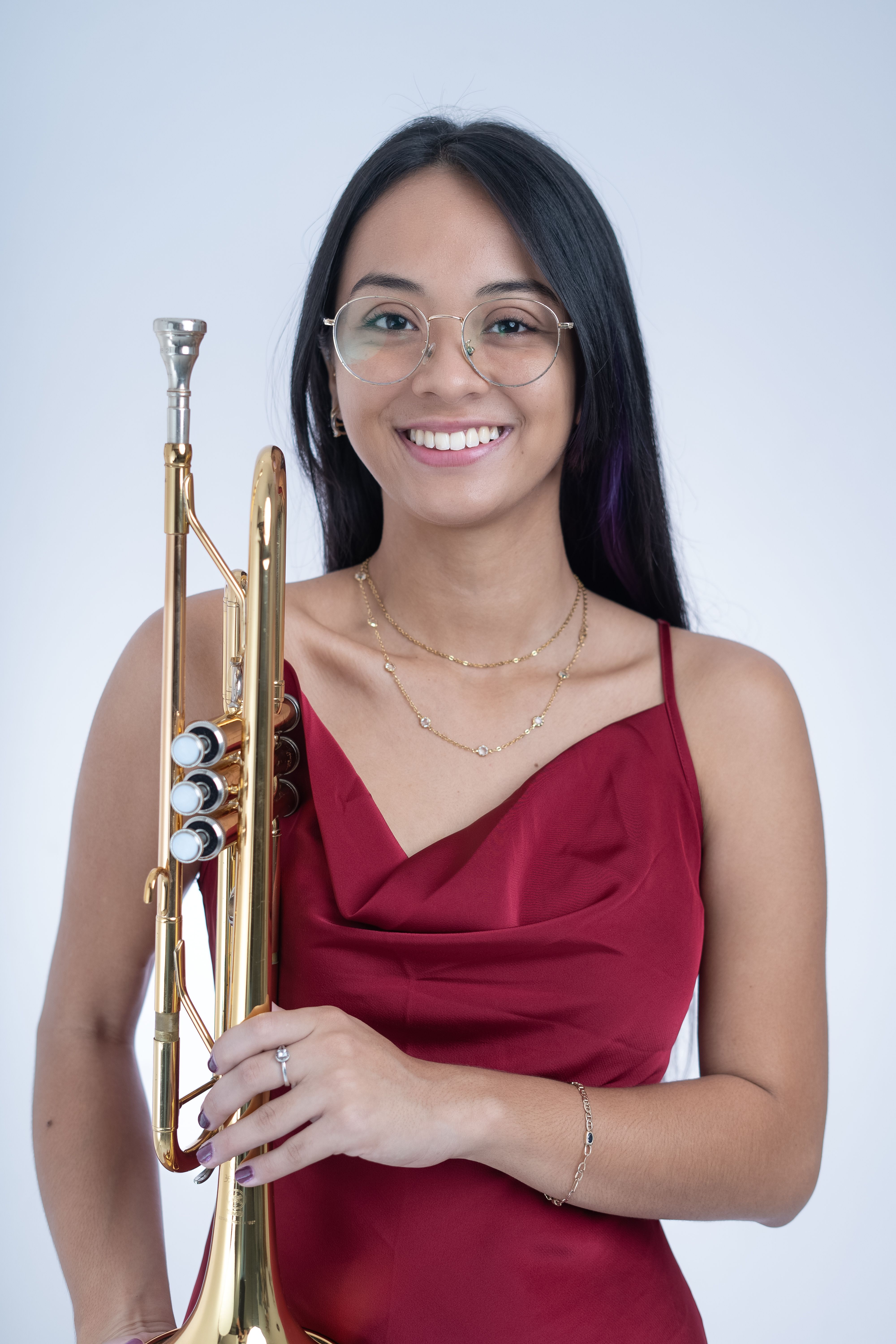 Studio Shot of a Young Woman Holding a Trumpet · Free Stock Photo