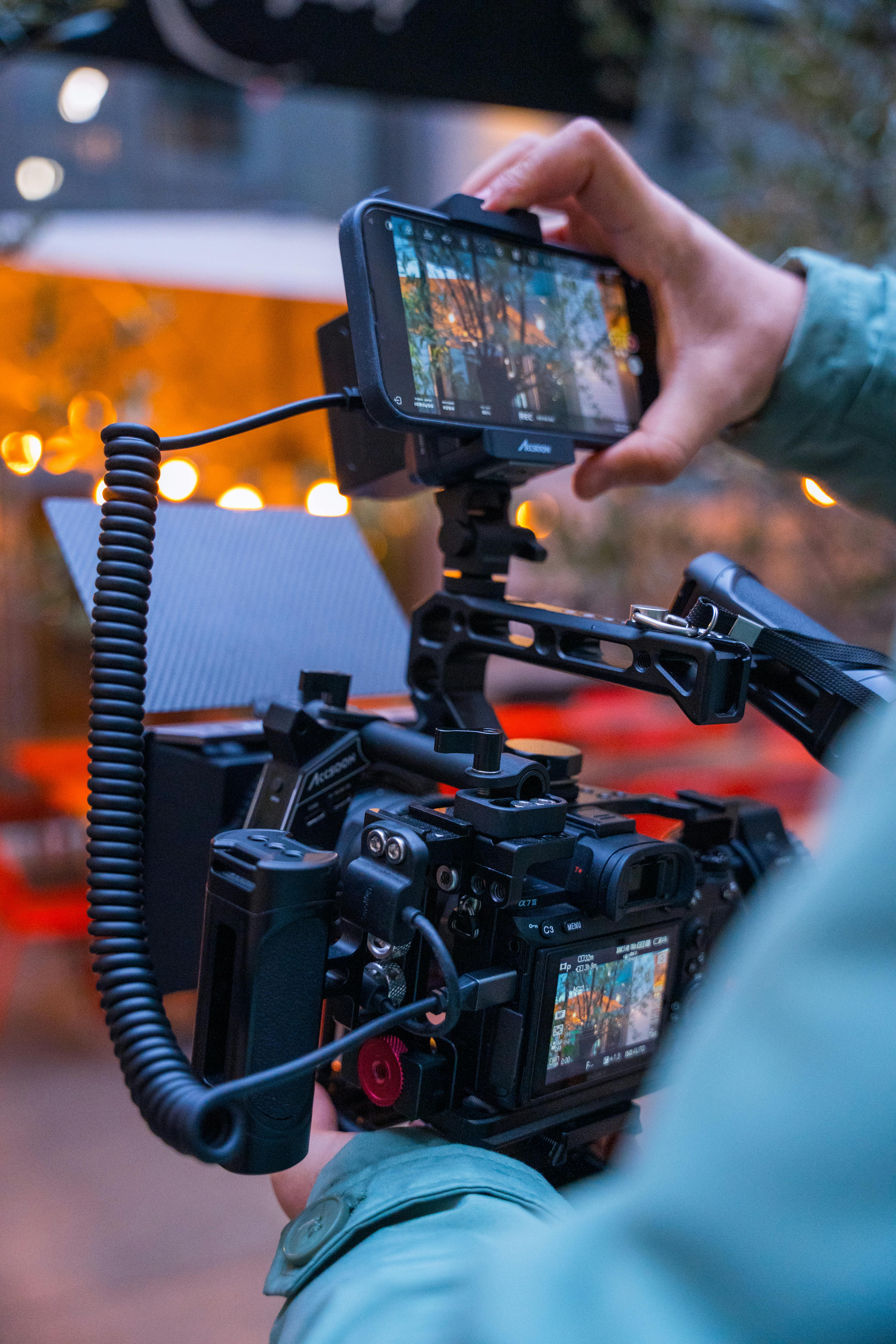Close-up of a Man Holding a Professional Filming Equipment · Free Stock ...