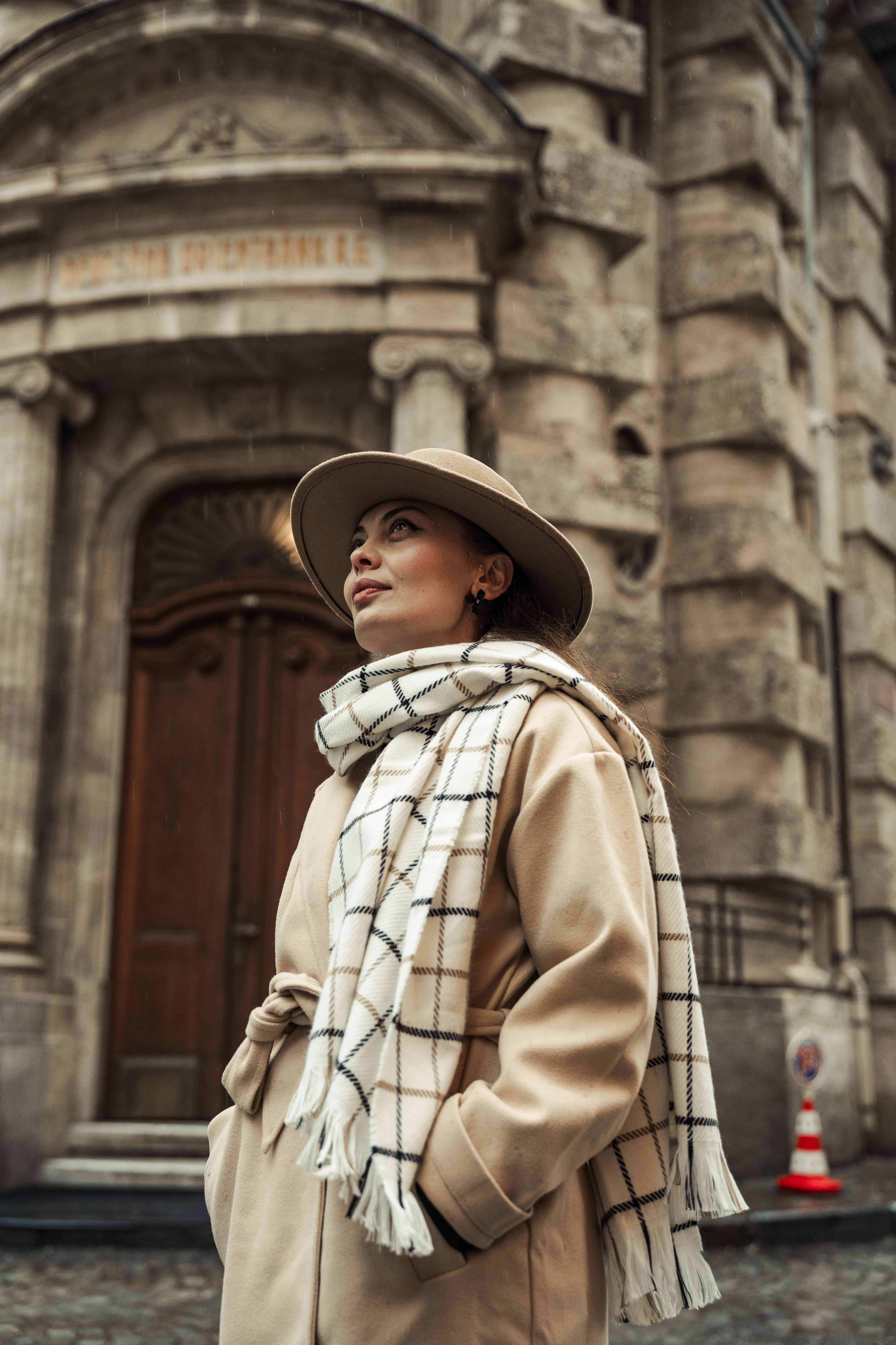 Model in a Beige Coat and Hat in Front of the Hotel Entrance · Free ...