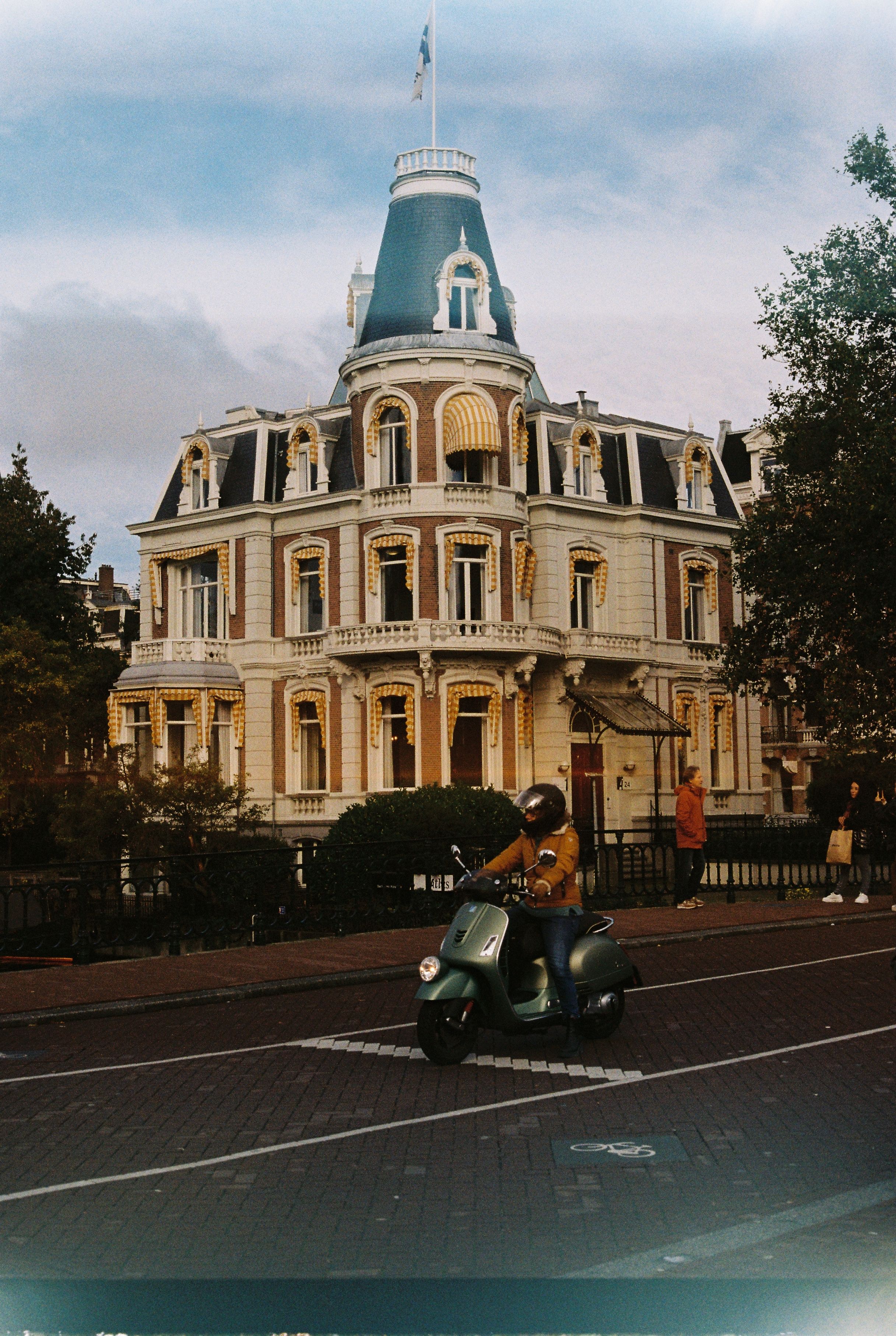 Riding a Scooter in Front of the Victorian House in Amsterdam · Free ...