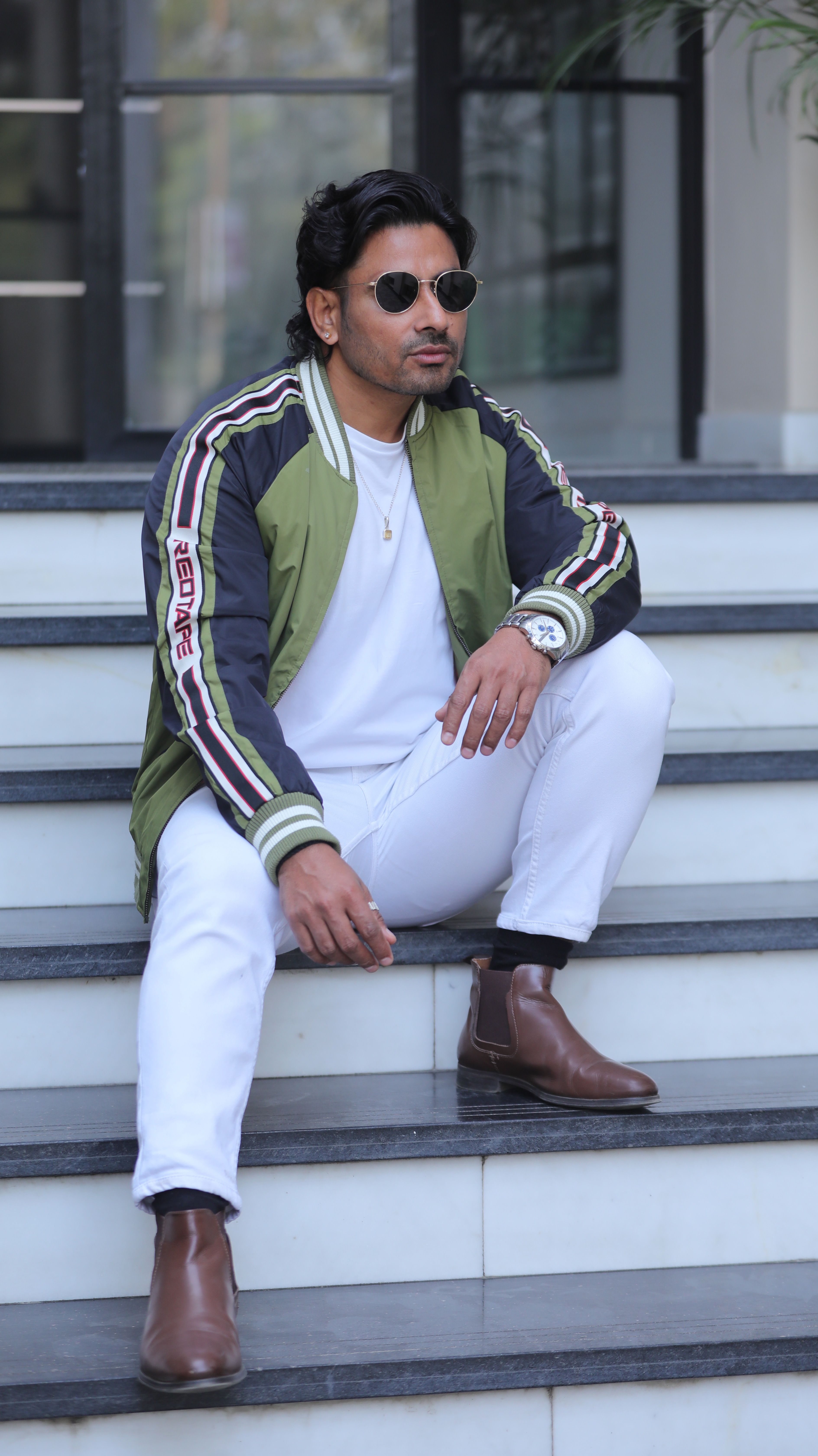 A Fashionable Man Sitting on Steps of a Building · Free Stock Photo