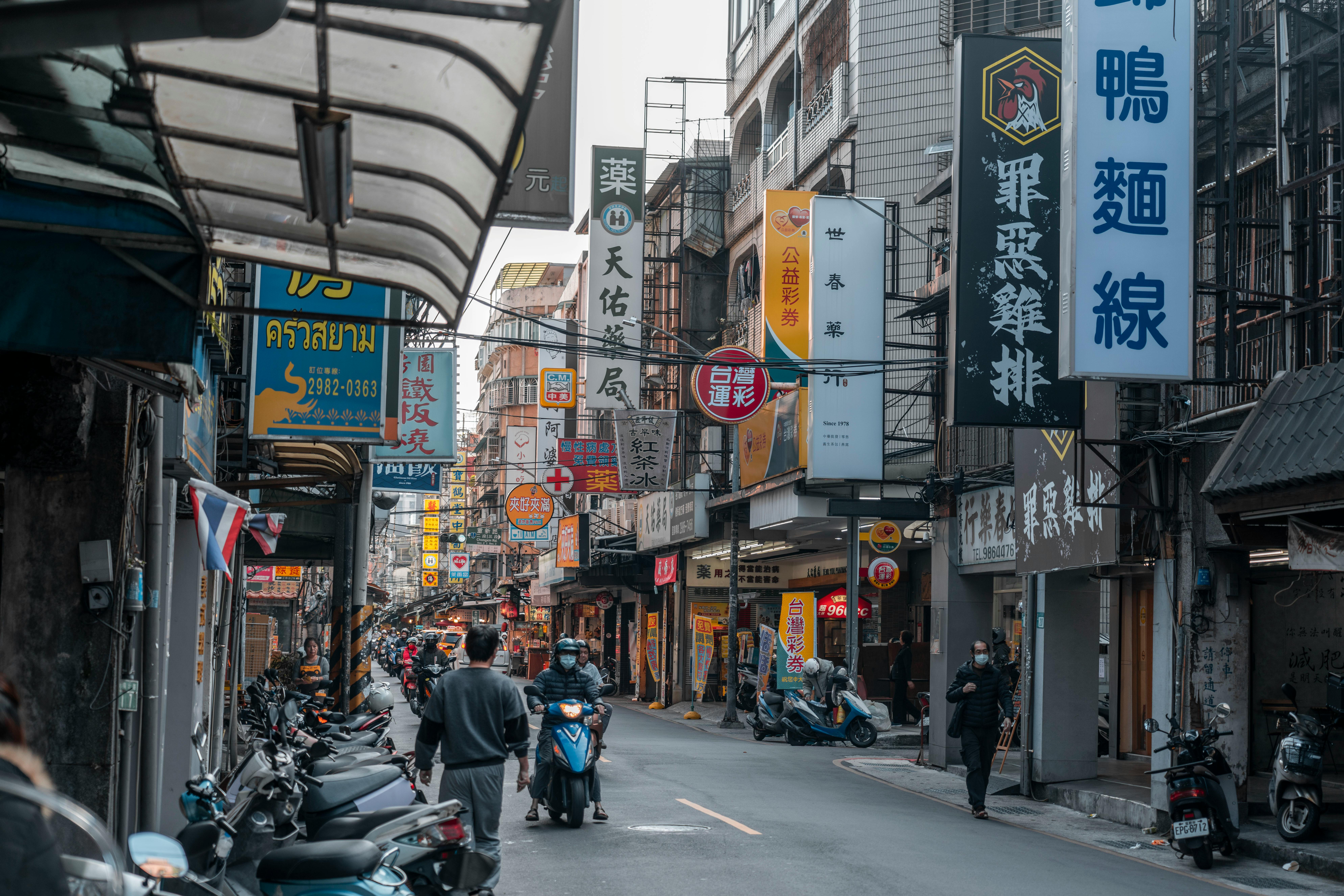 Gray Asphalt Street in Between Yellow and White Concrete Buildings at ...
