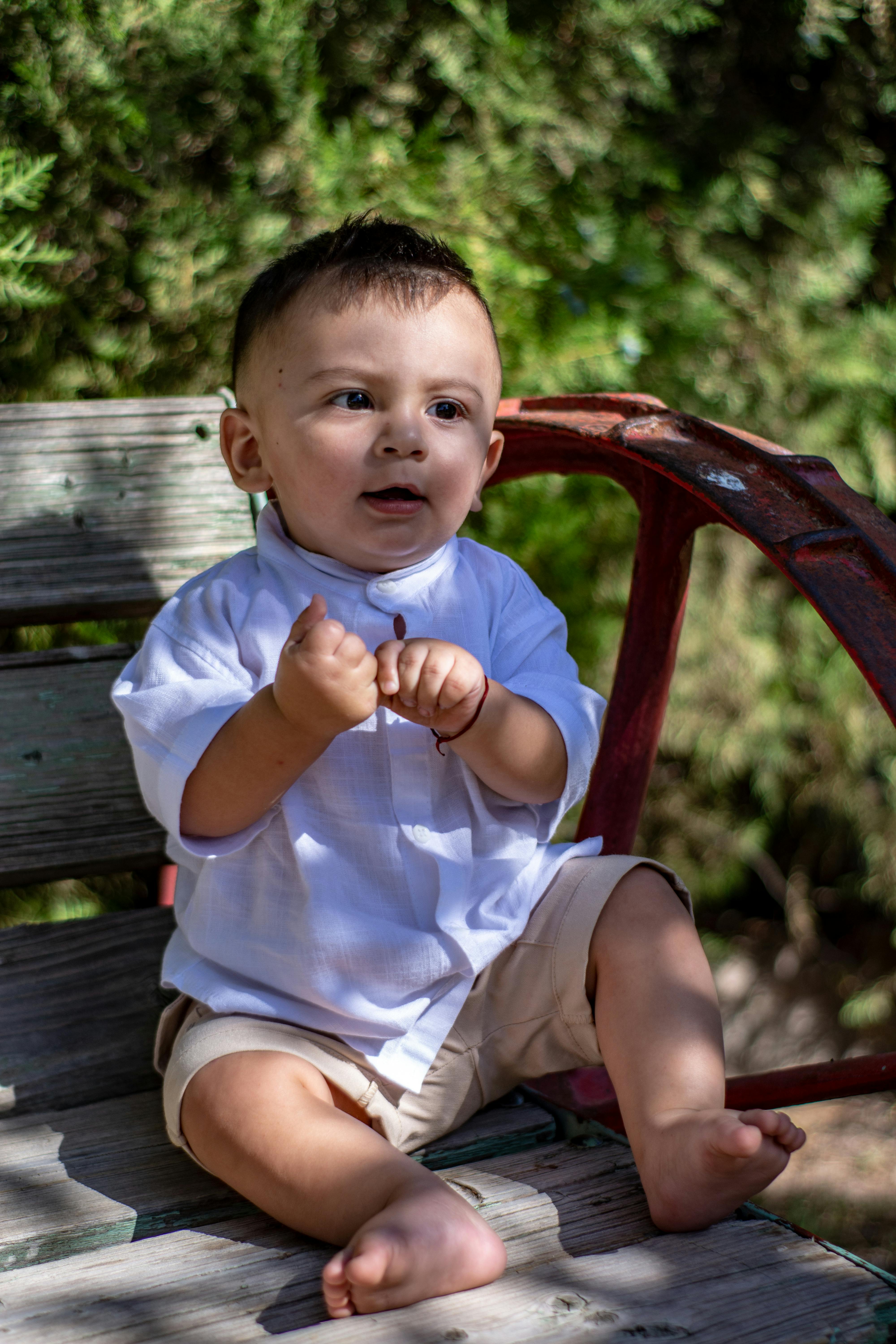 Toddler Sitting on a Bench · Free Stock Photo