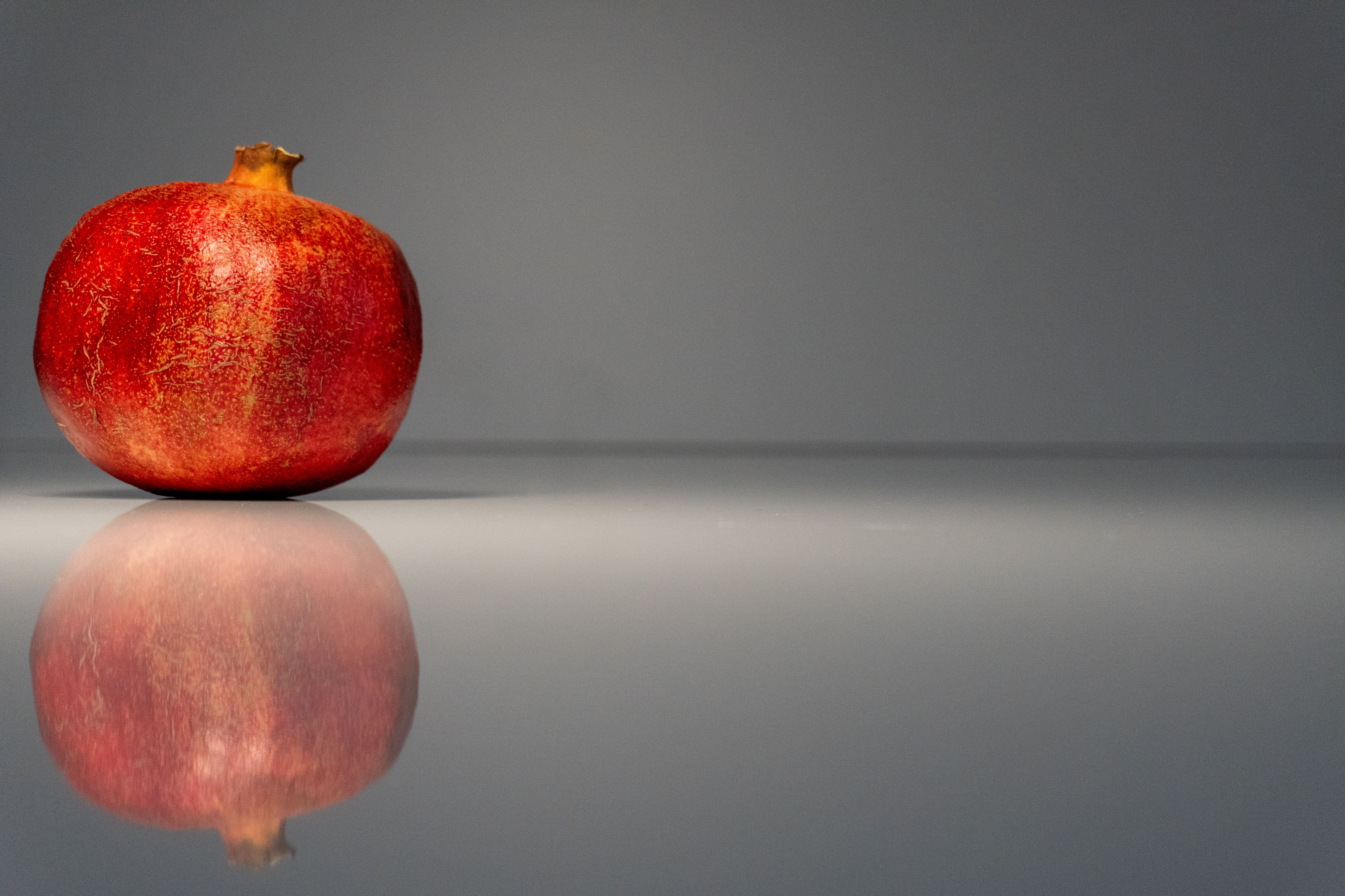 Pomegranate on Gray Background · Free Stock Photo