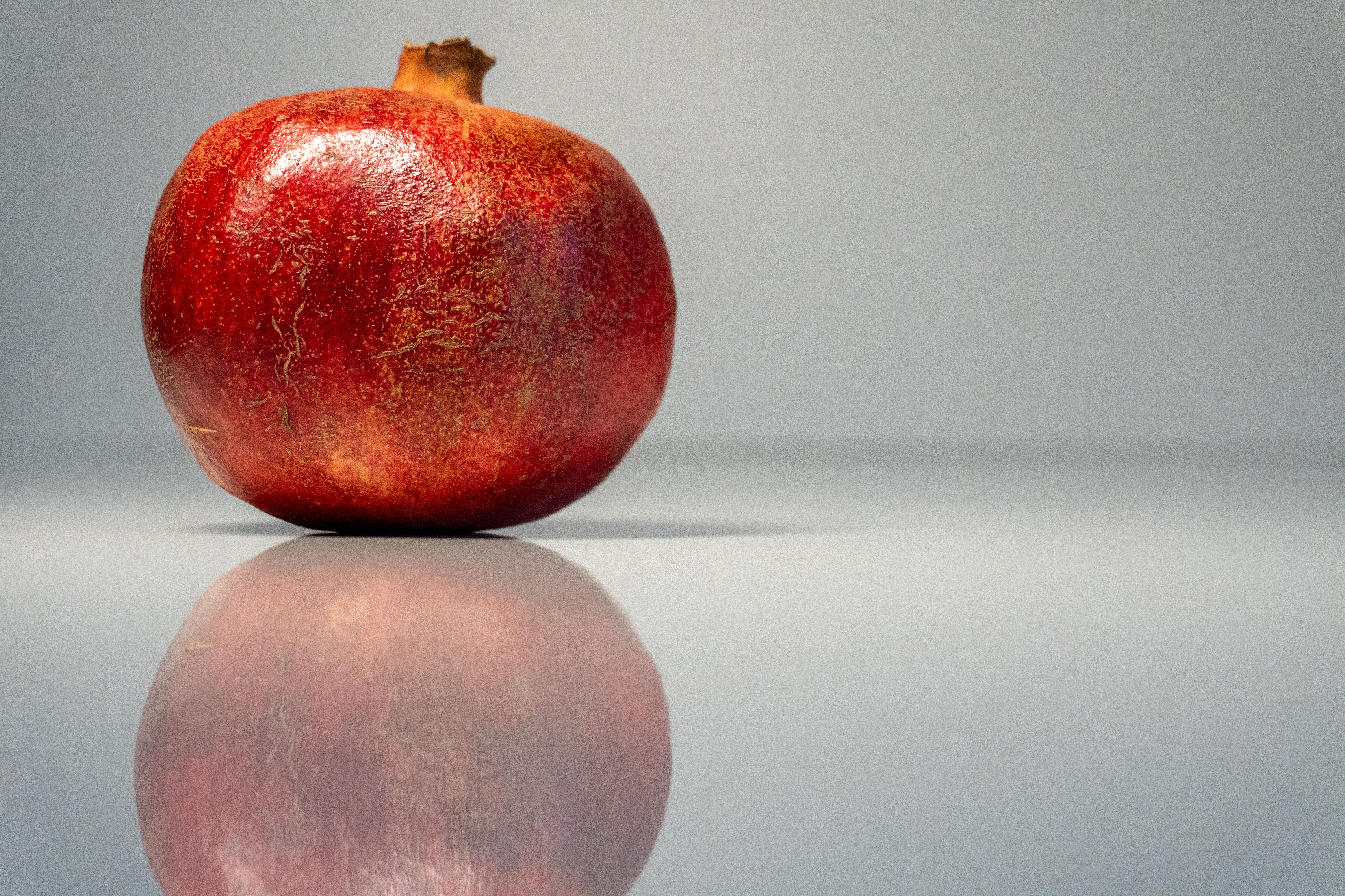 Pomegranate on Gray Background · Free Stock Photo
