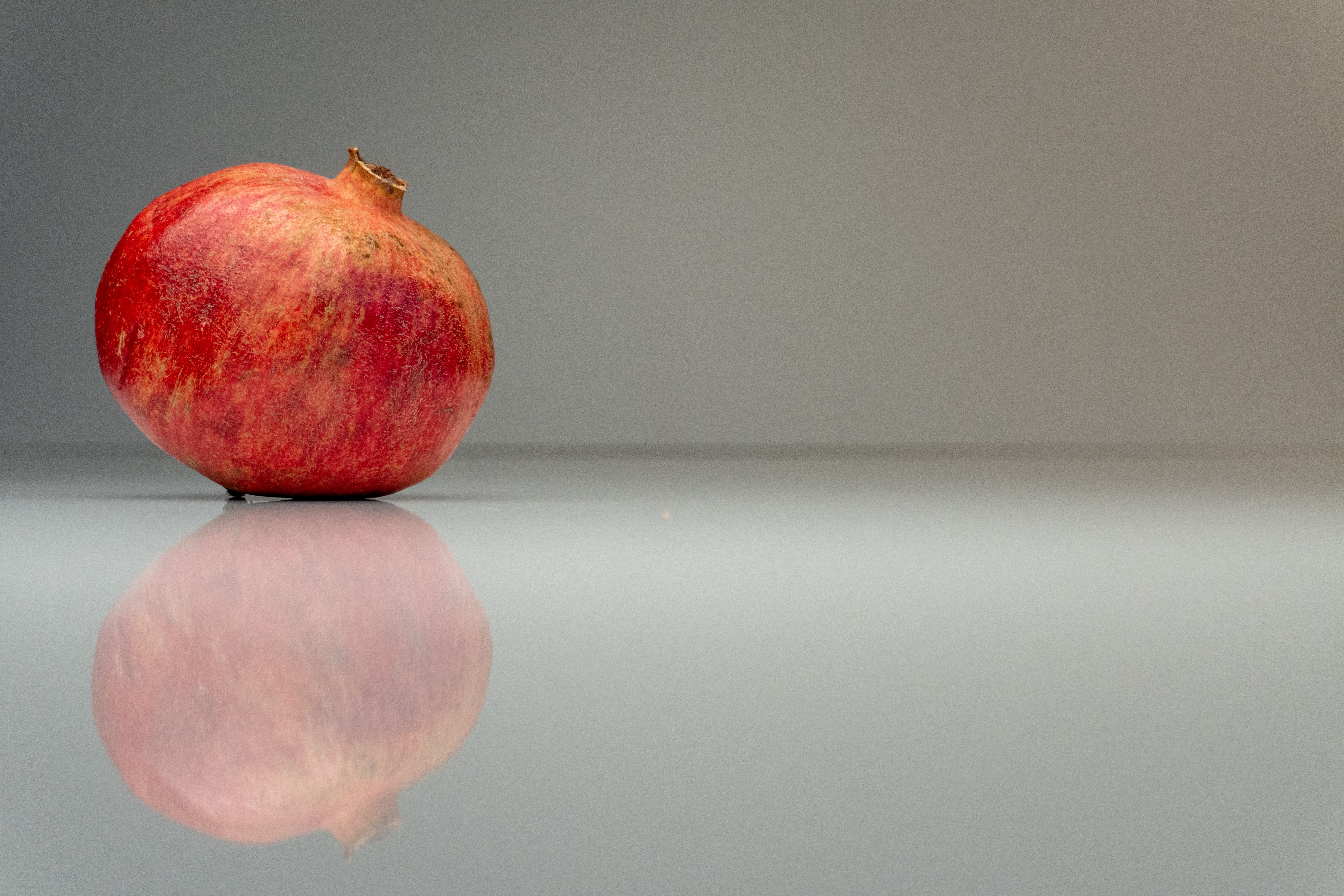 Pomegranate on Gray Background · Free Stock Photo