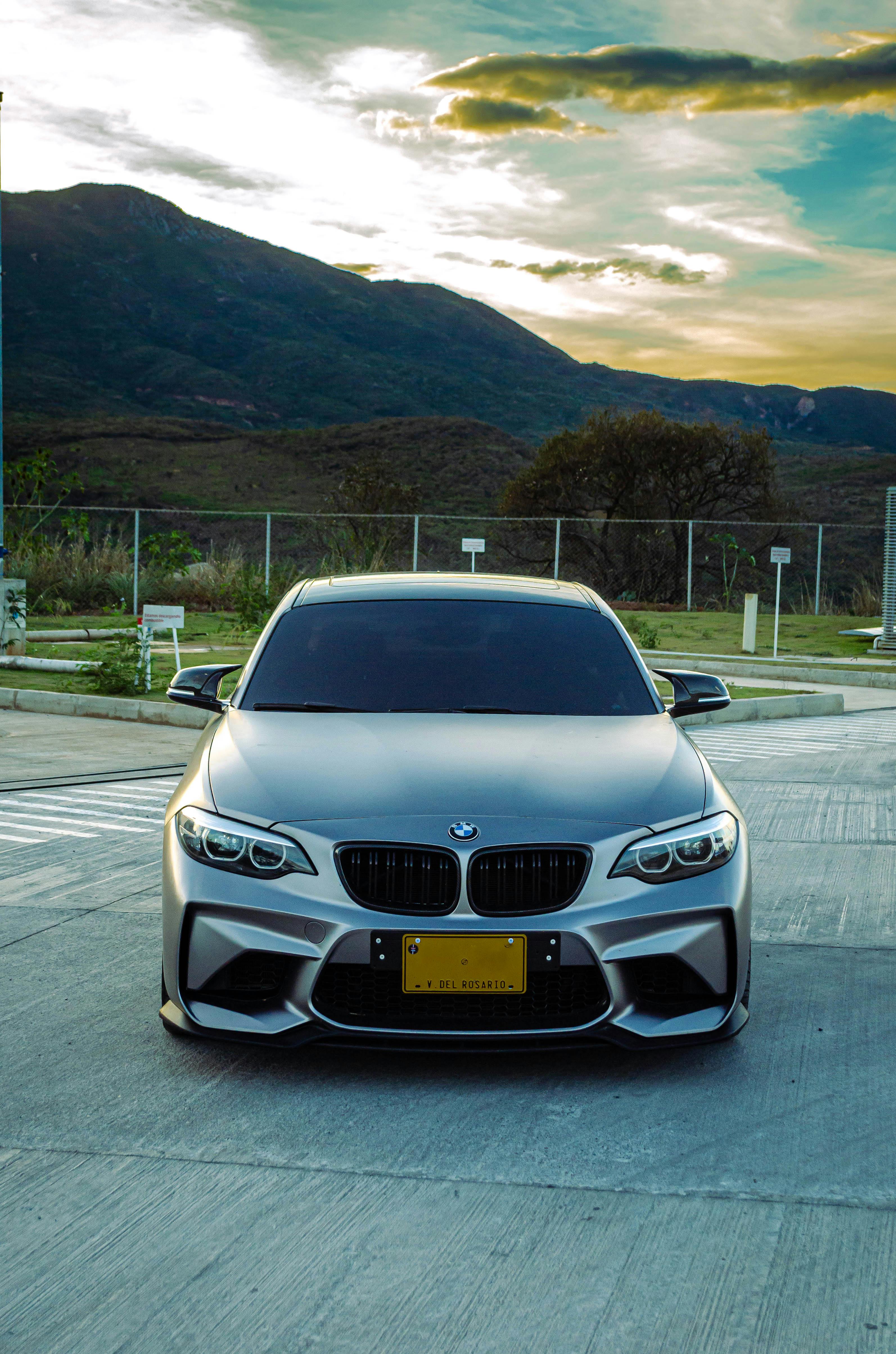 Silver BMW Car Standing in a Parking Lot at Sunset · Free Stock Photo