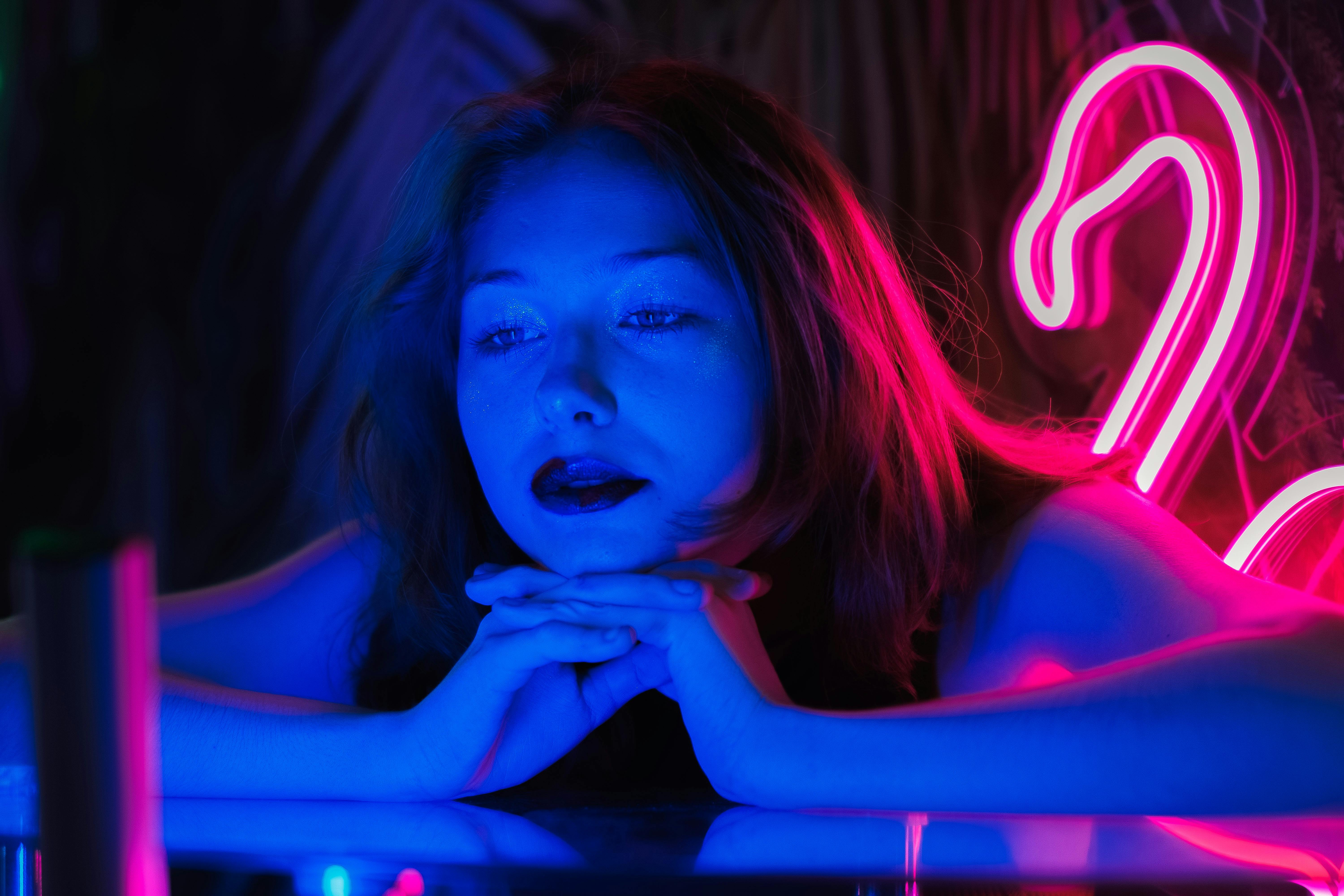 Blue Light over Woman Lying Down with Hands under Chin · Free Stock Photo