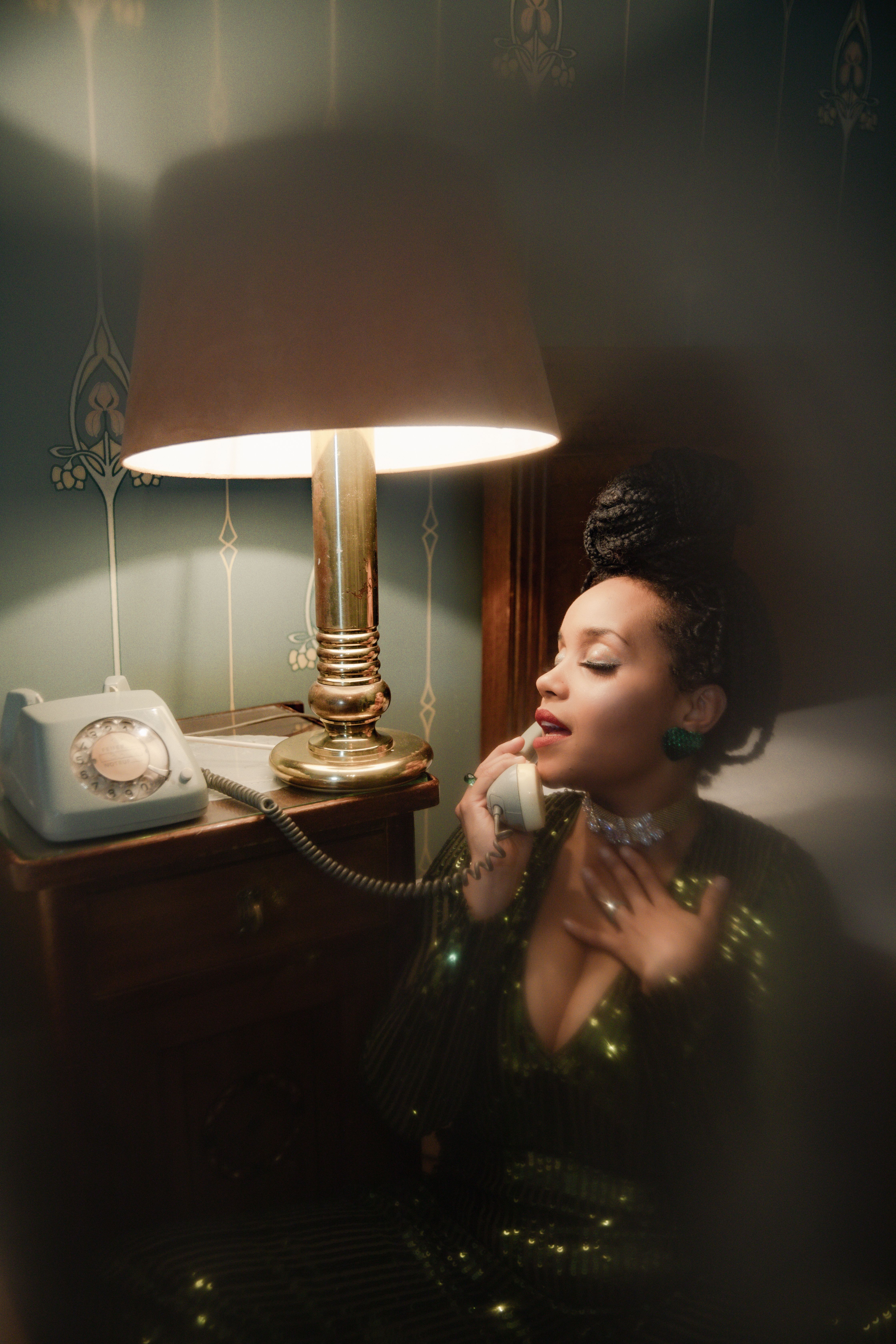 Woman in Glistening Dress in a Retro Hotel Room · Free Stock Photo