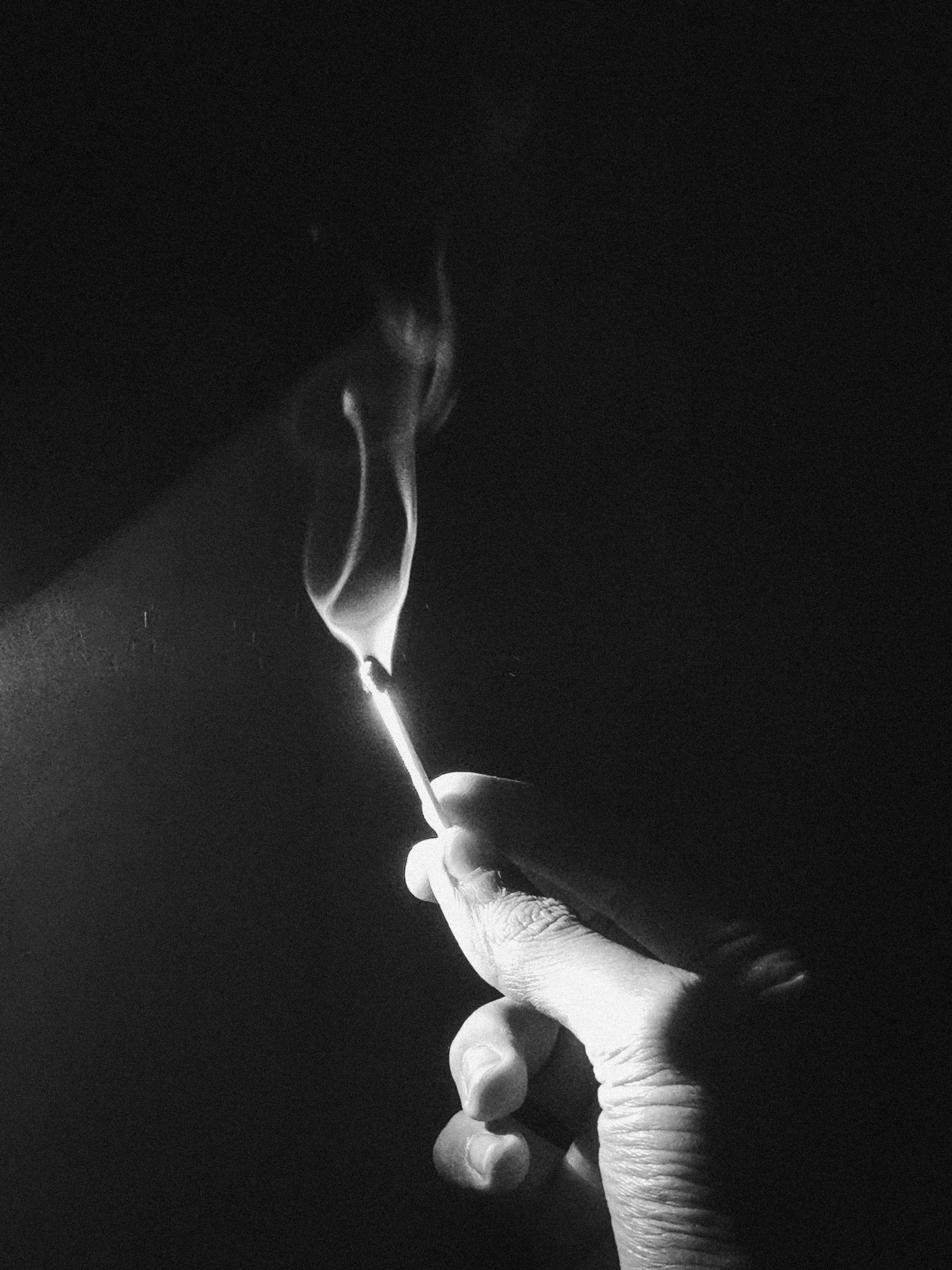 Hand with Smoking Match · Free Stock Photo