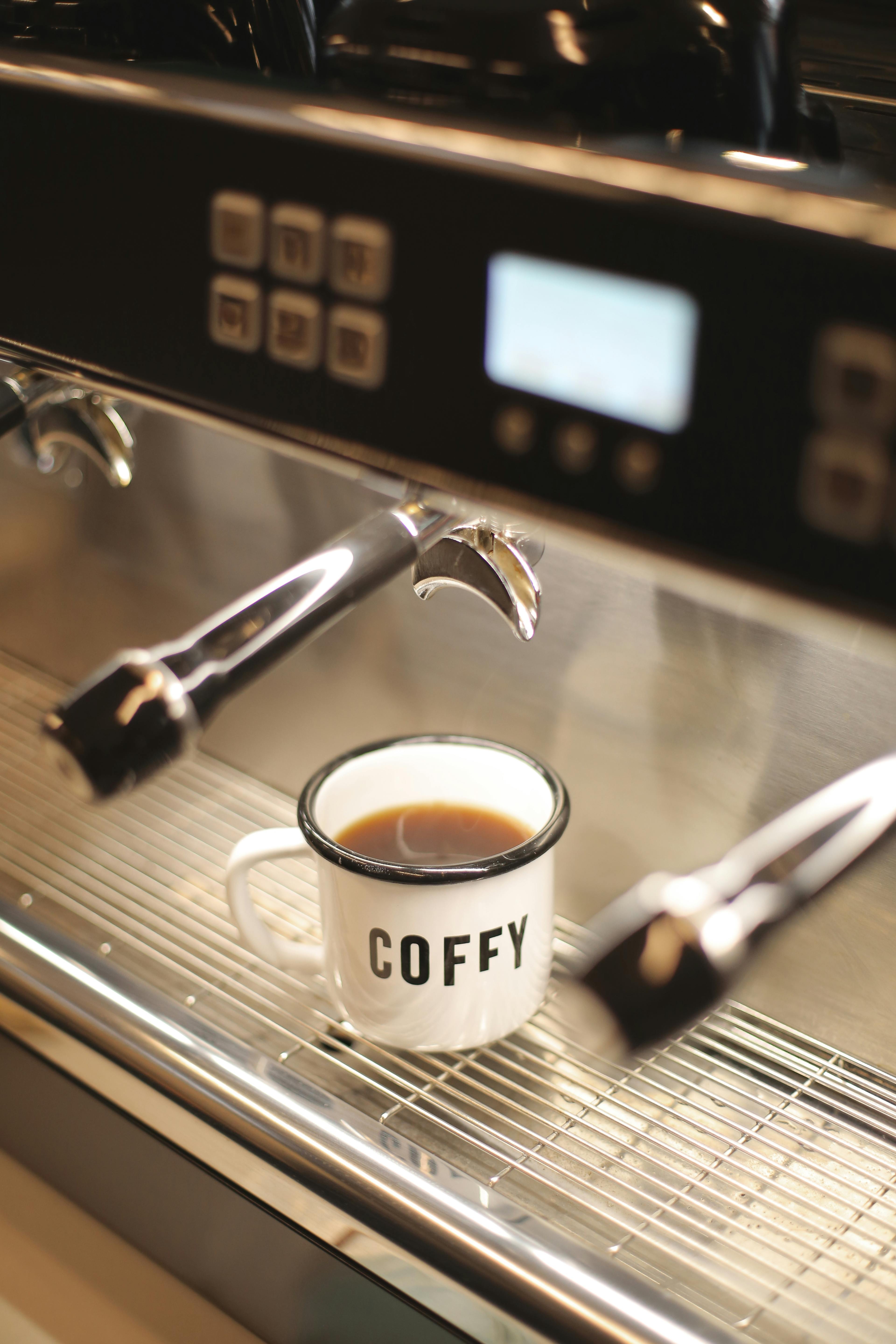 Close-up of a Cup of Coffee Standing on a Coffee Machine · Free Stock Photo