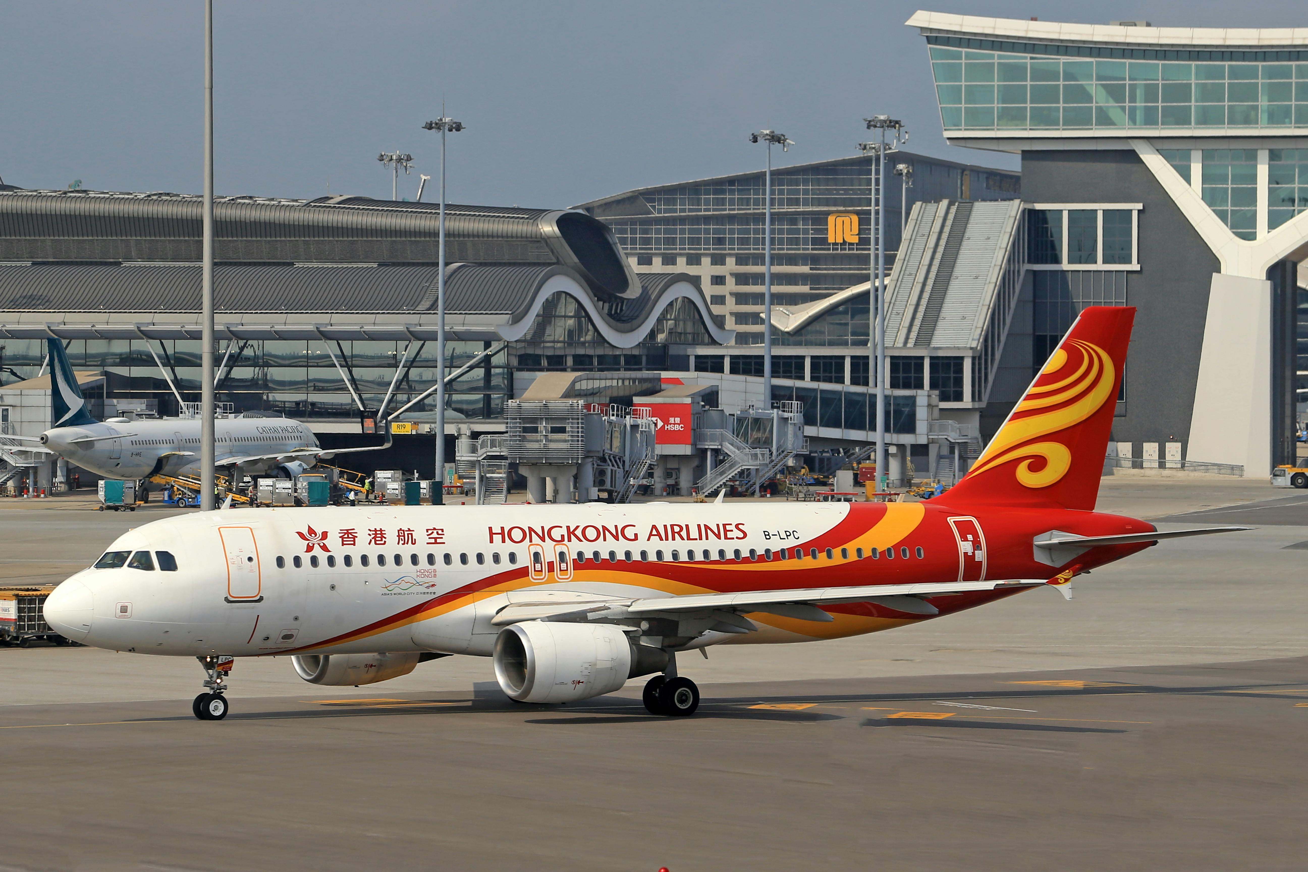 A chinese airplane is parked at an airport · Free Stock Photo