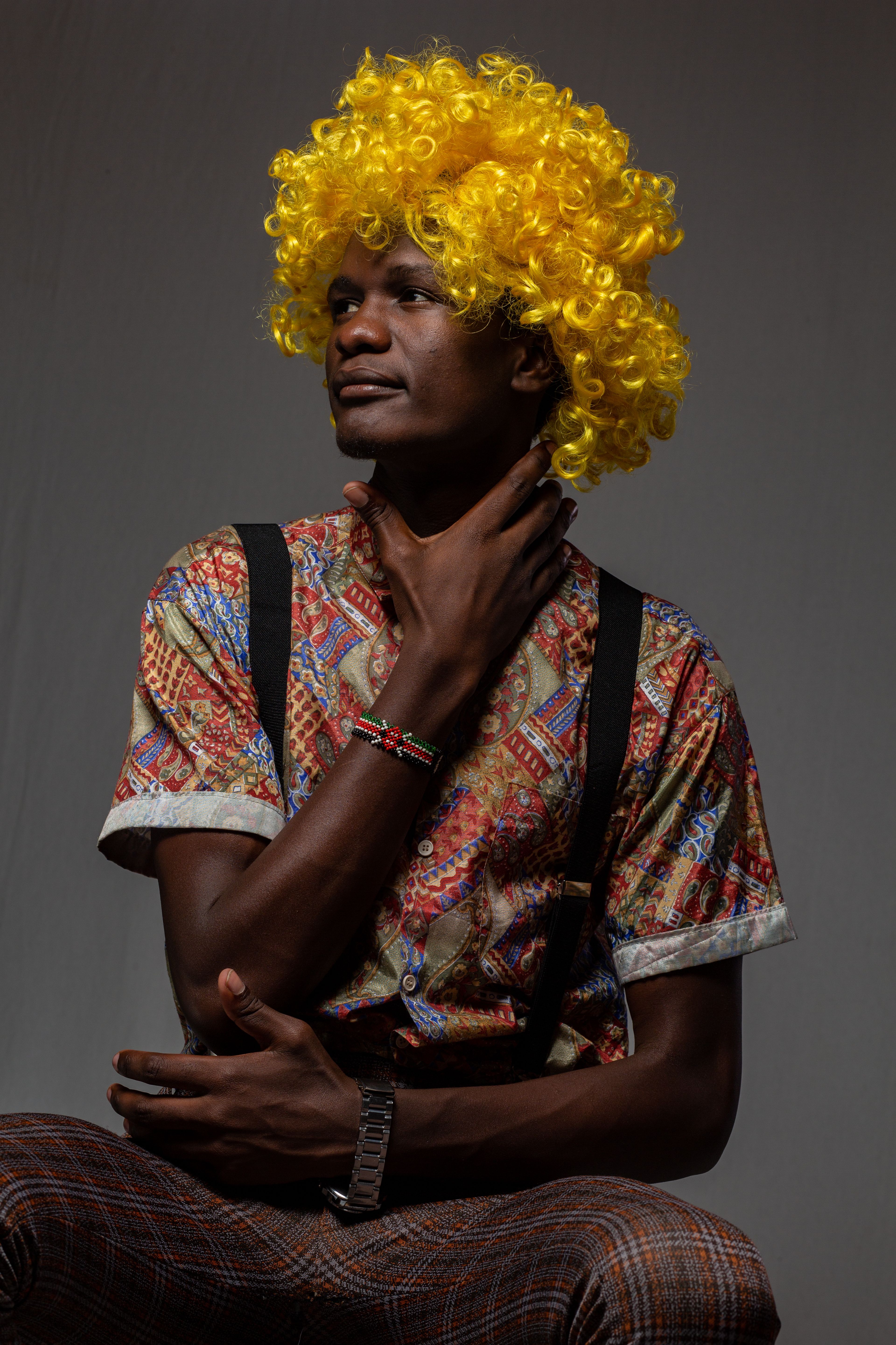 Man with Yellow Afro Hair Posing with Hand on Throat · Free Stock Photo