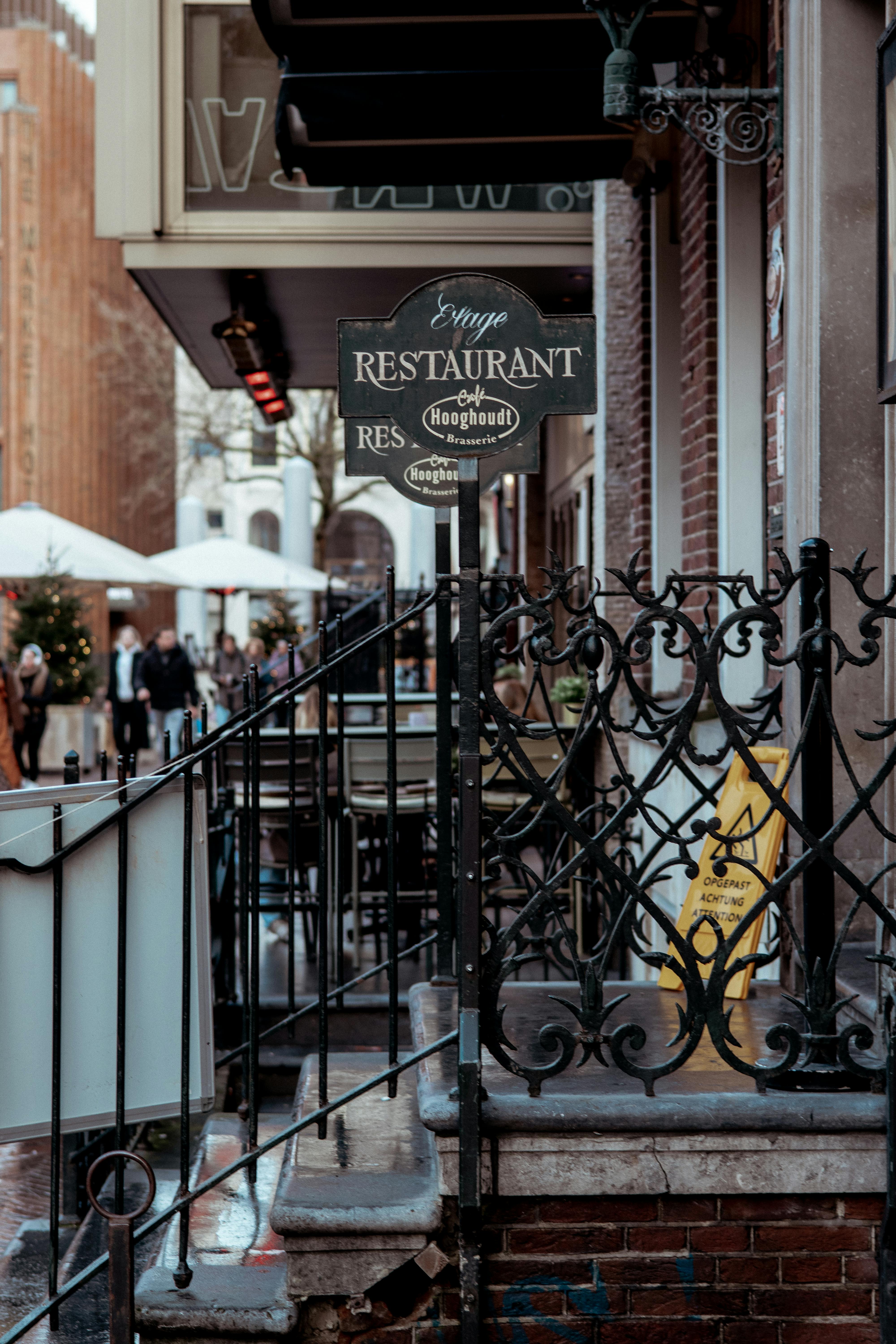Restaurant Board behind Stairs Railing · Free Stock Photo
