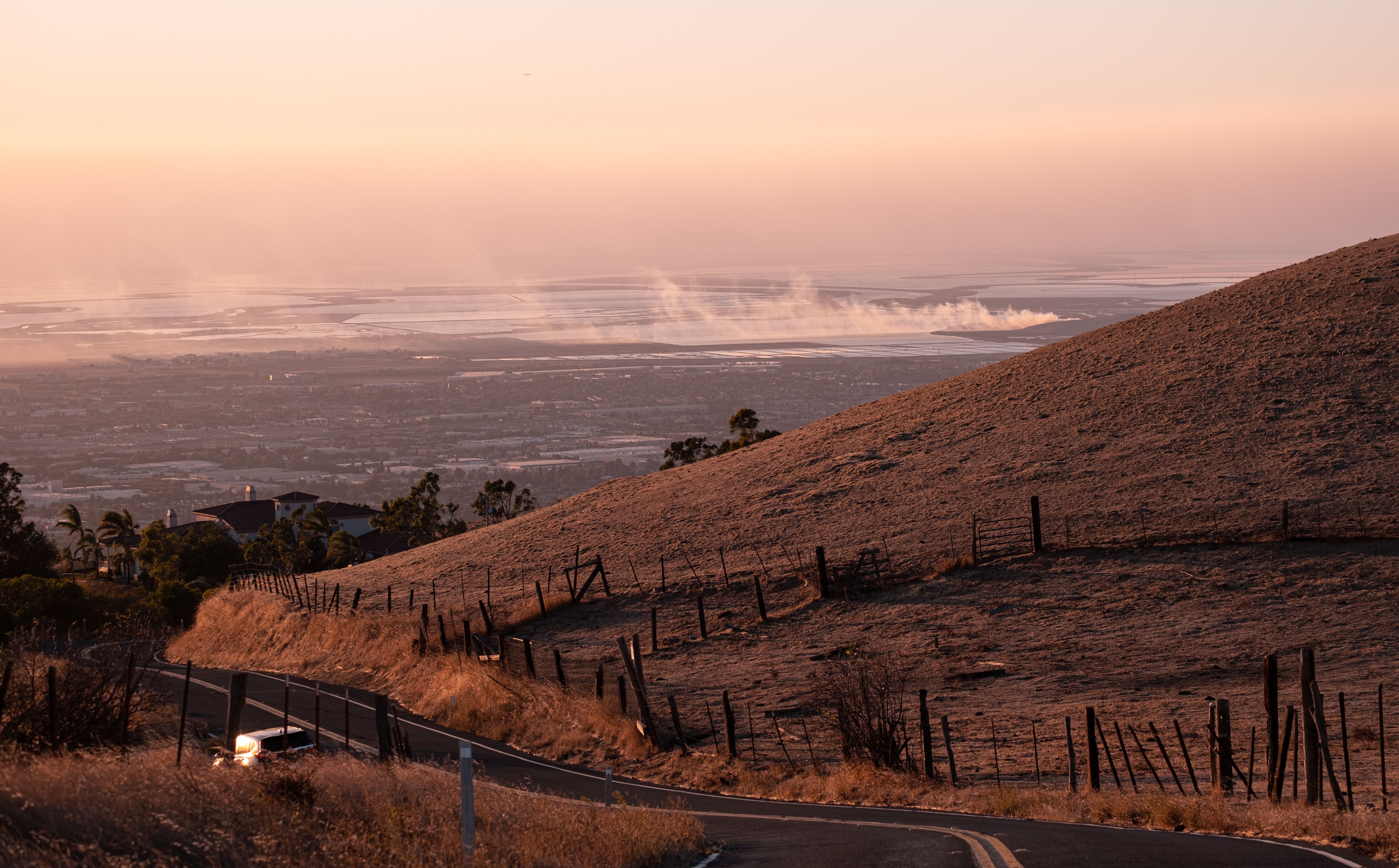 A view of a road with a hill in the distance · Free Stock Photo