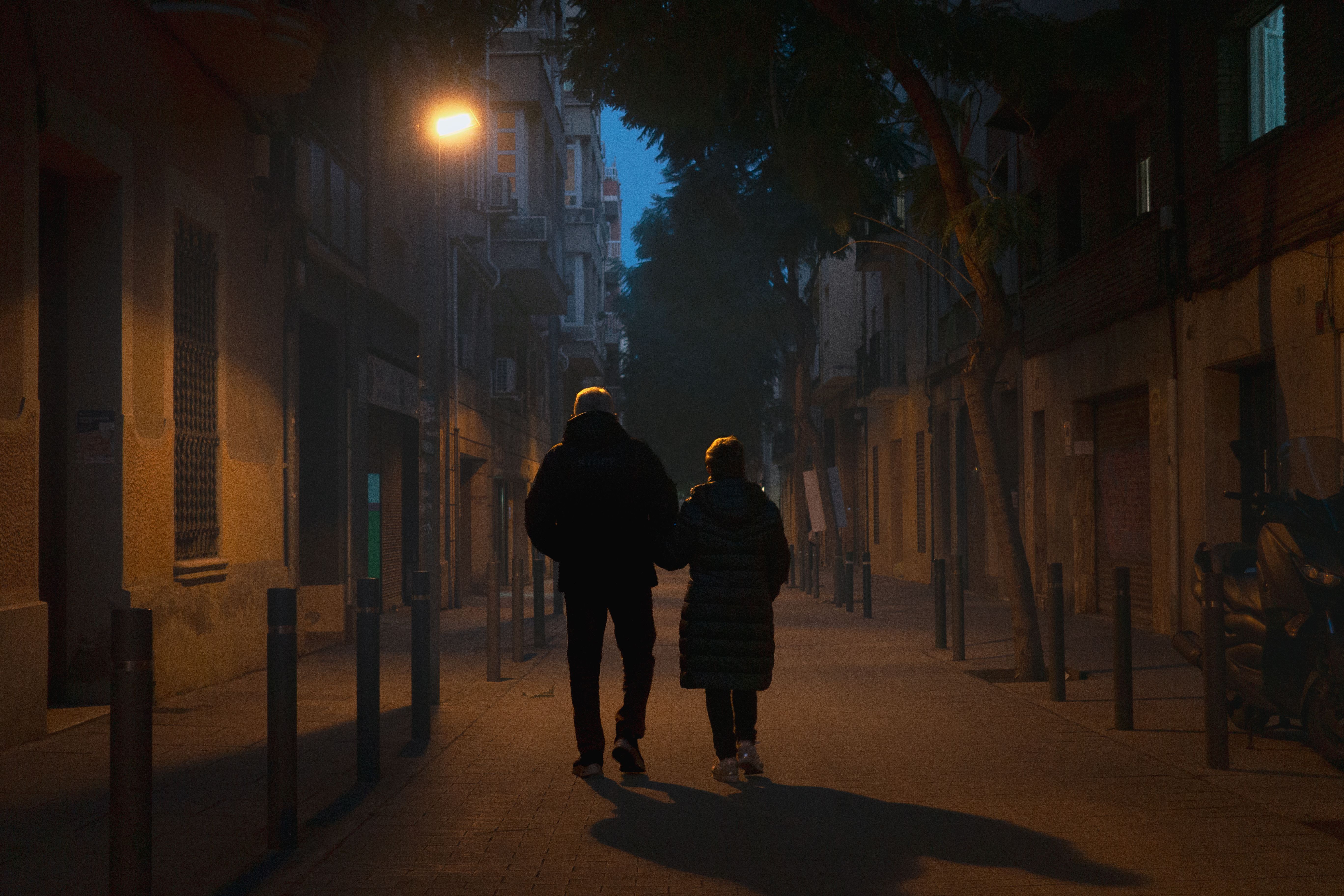 Couple Walking at Night in Urban Street Scene · Free Stock Photo