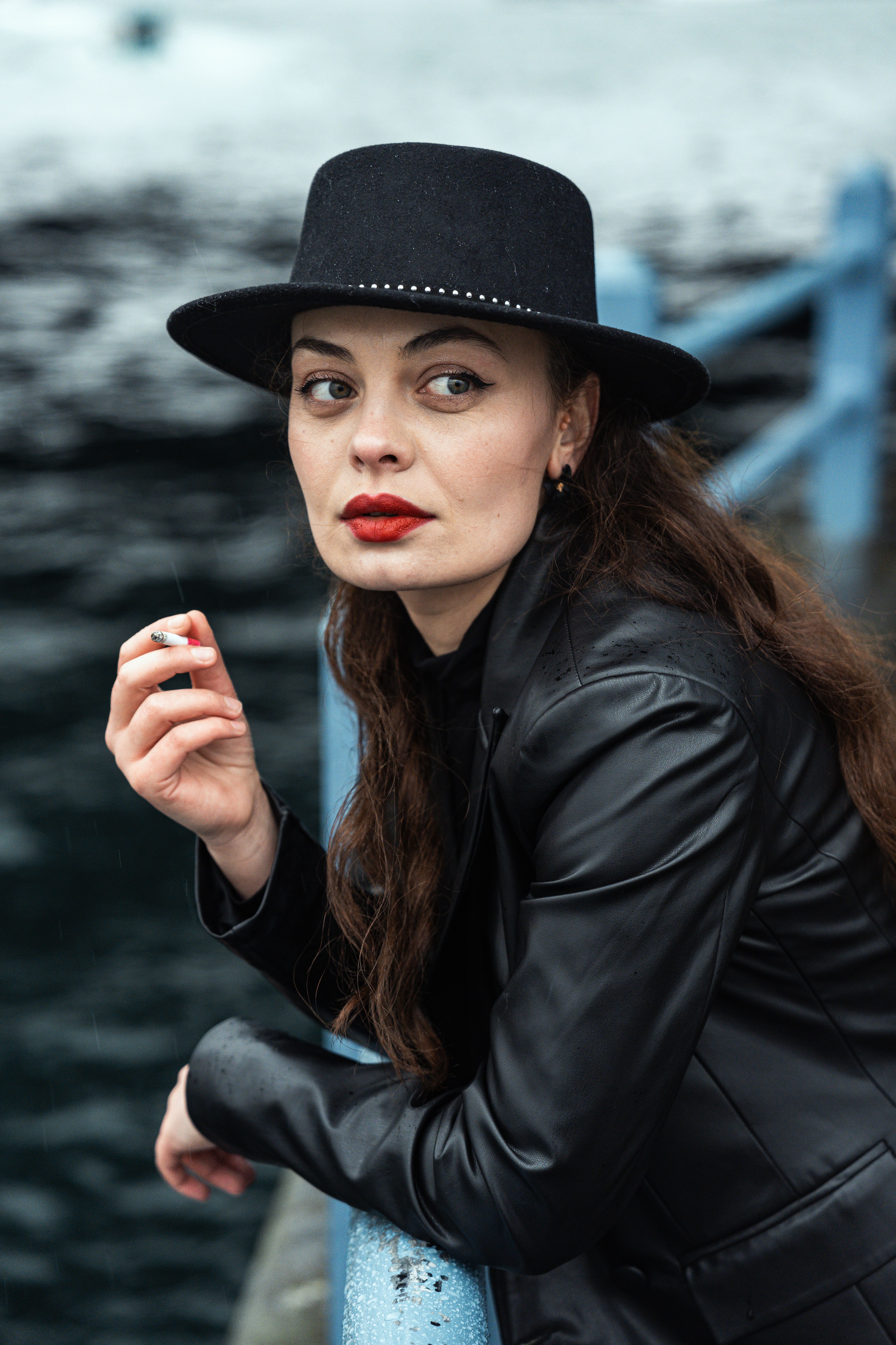 Smoker in Leather Jacket Posing by Railing · Free Stock Photo