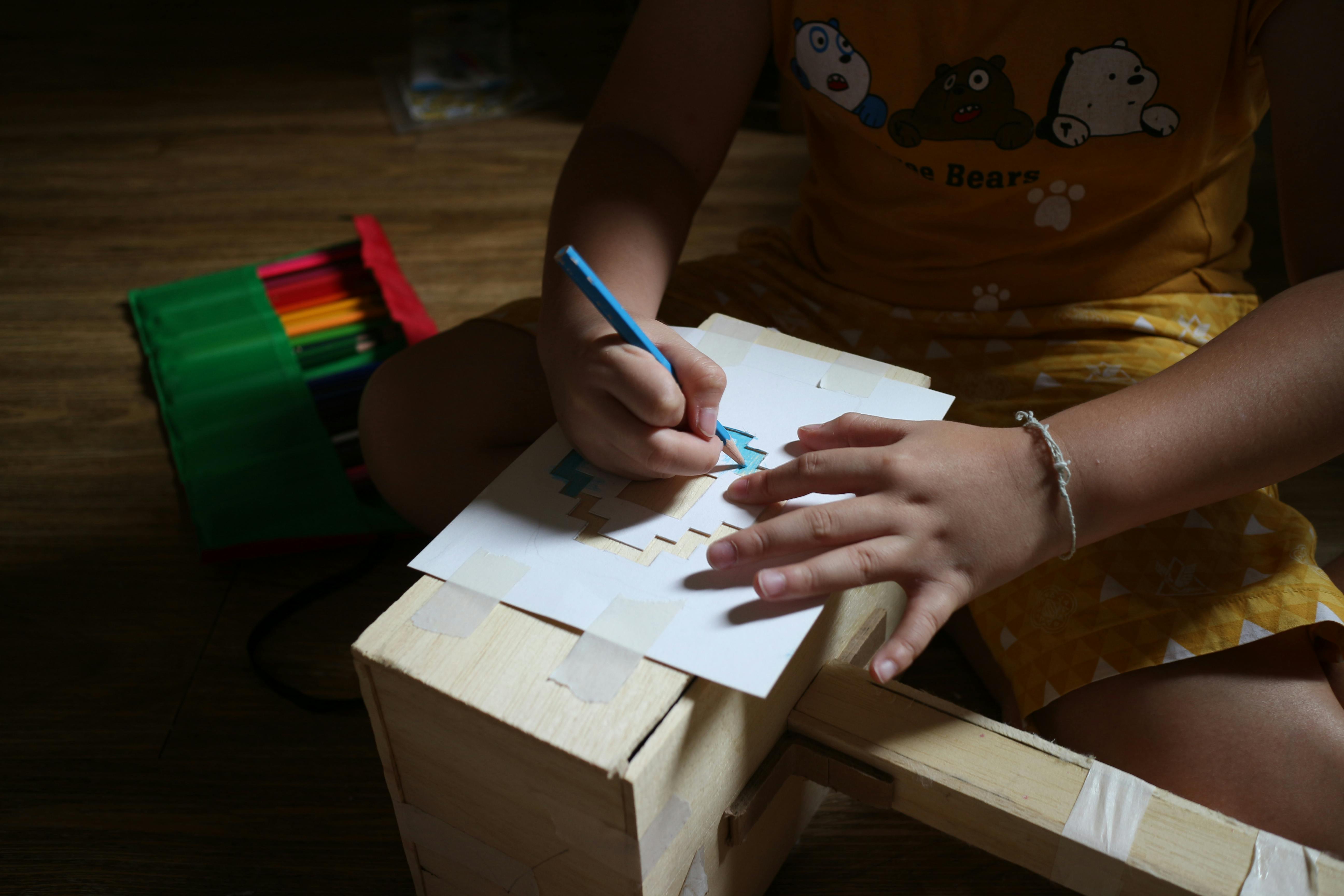 Child Painting a Box · Free Stock Photo