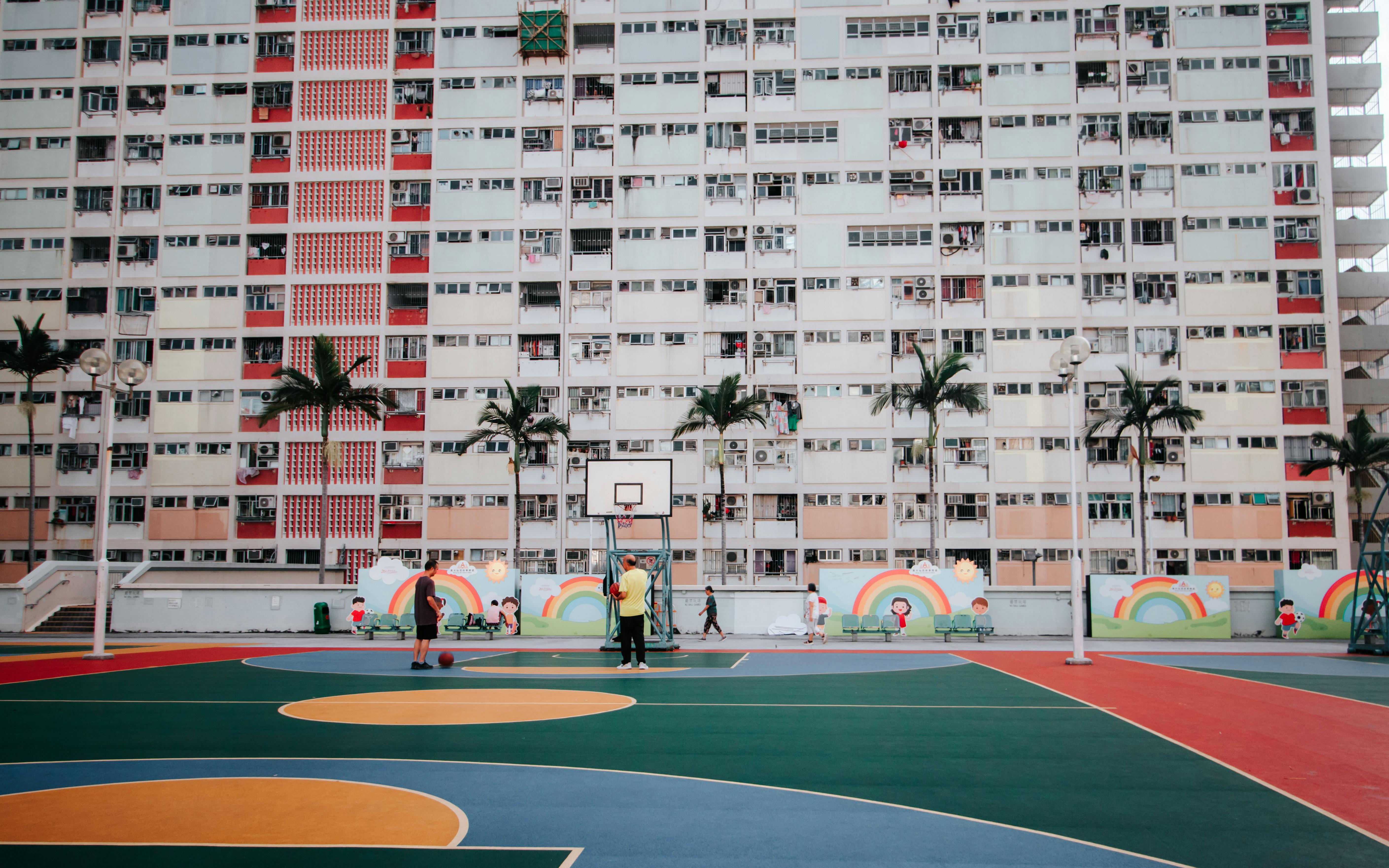 Colored Basketball Court beside Block of Flats · Free Stock Photo