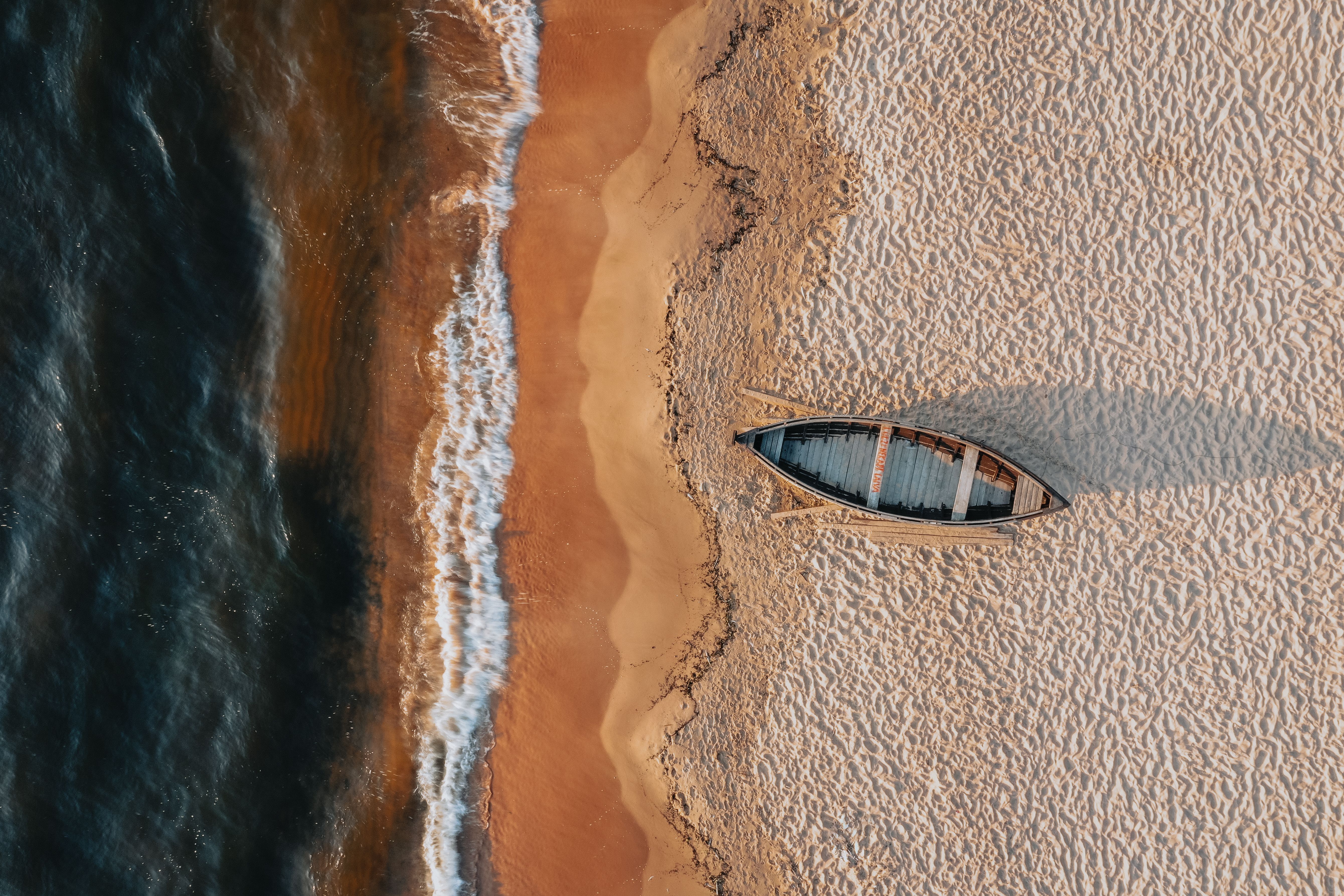An aerial view of a boat on the beach · Free Stock Photo