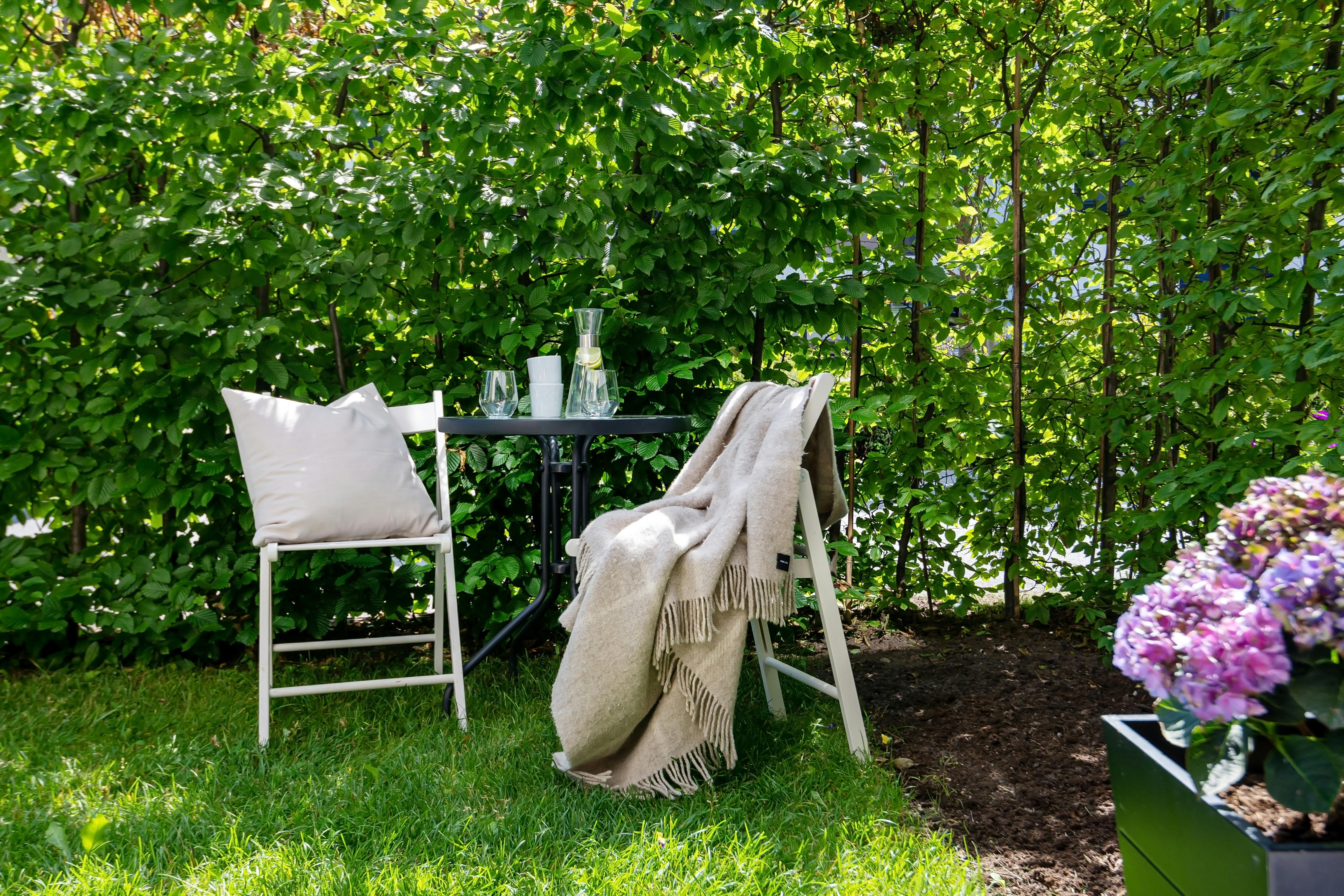 White Chairs with Pillows in a Backyard · Free Stock Photo