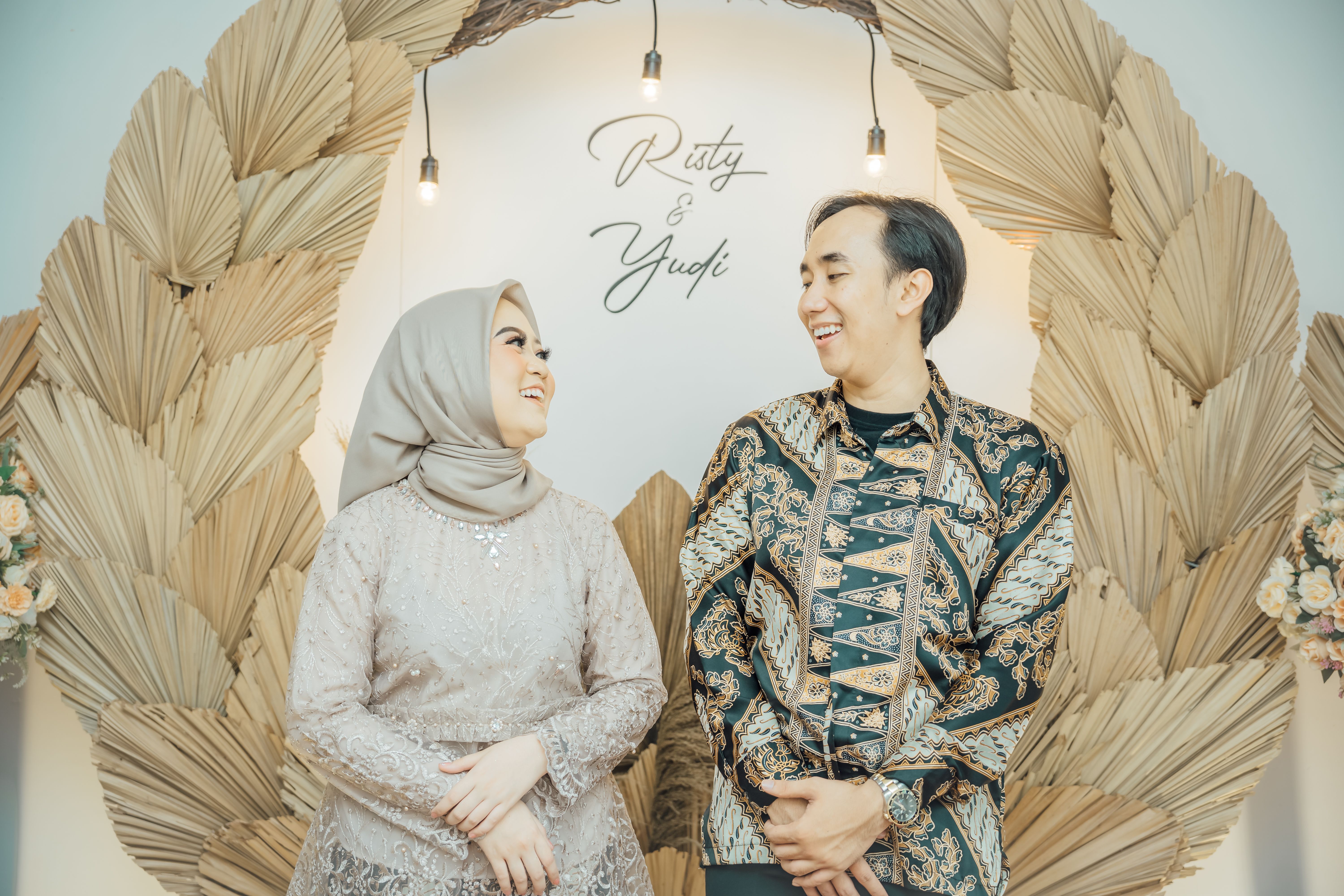 Bride and Groom in Traditional Clothing Standing next to Each Other and ...
