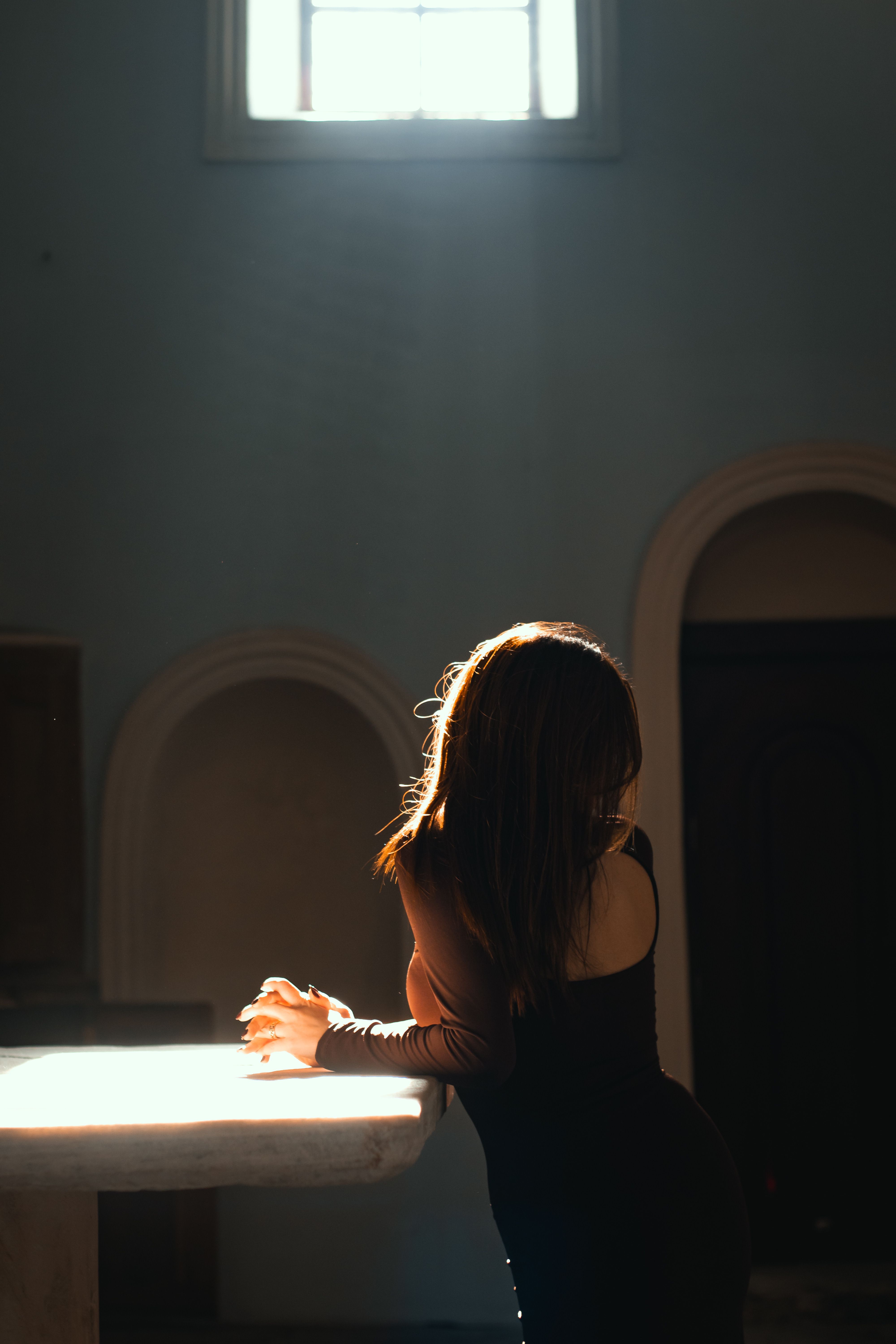 Elegant Woman in Black Dress Standing by Table · Free Stock Photo