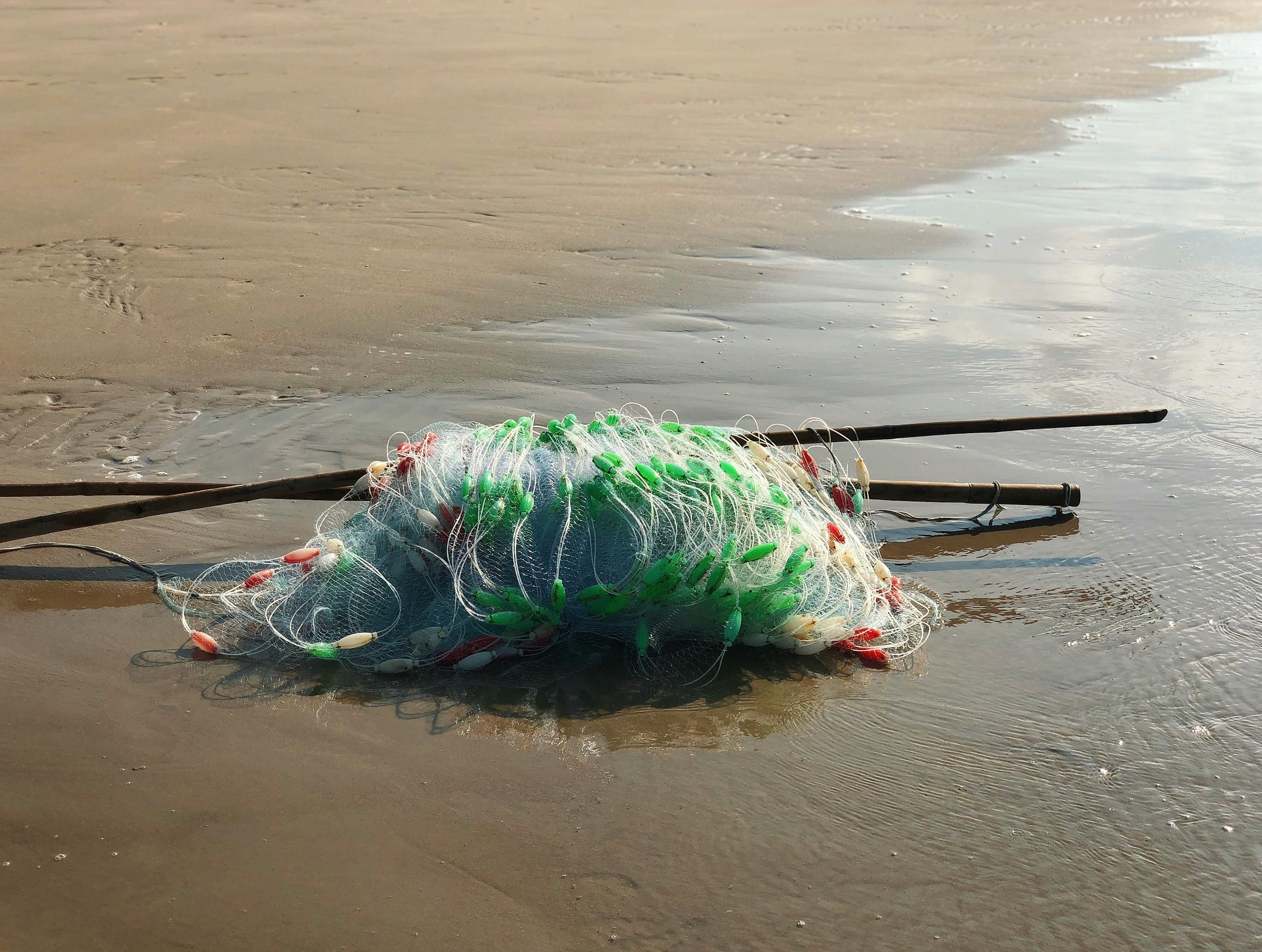A Plastic Fishing Net Lying on a Beach · Free Stock Photo