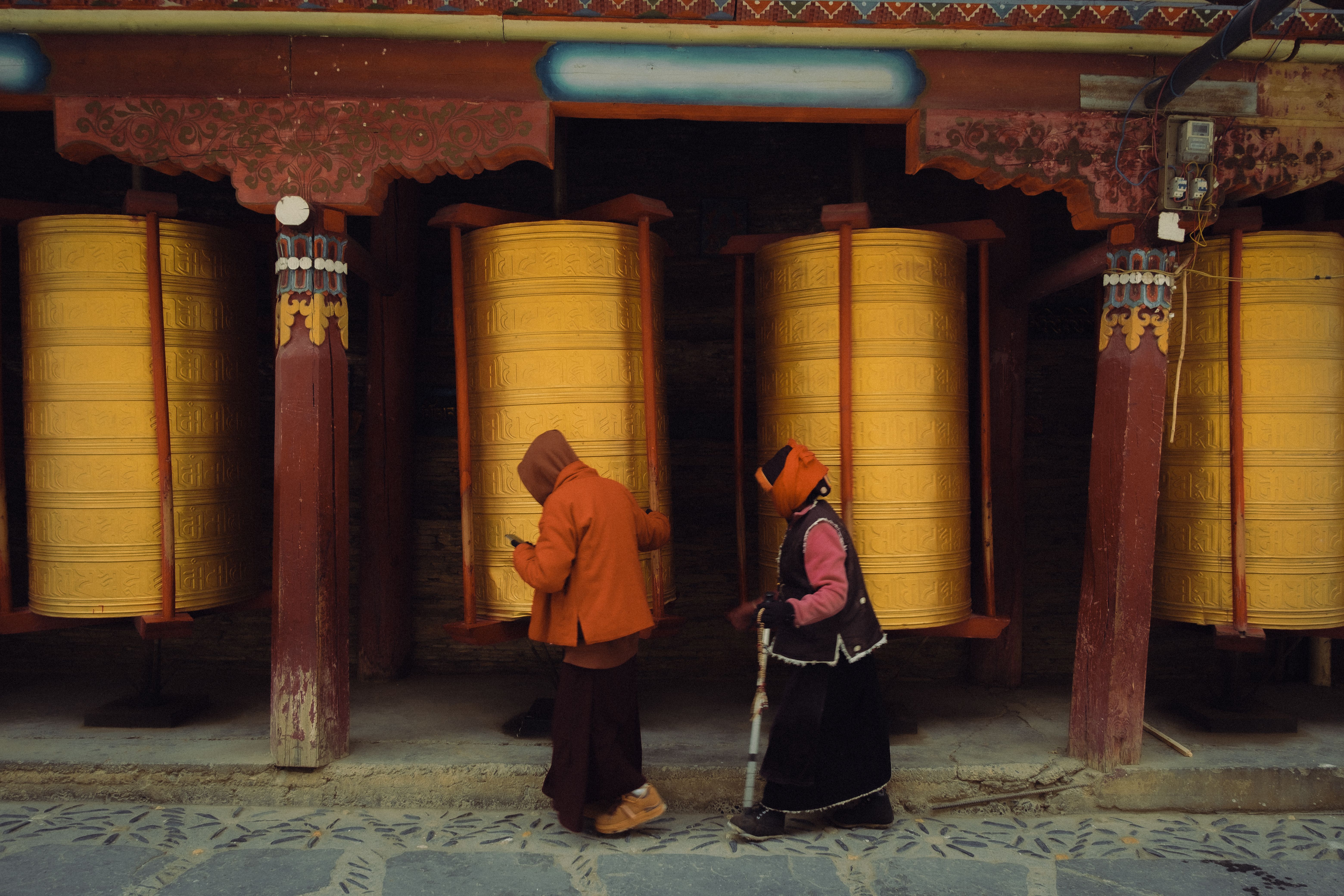 Elderly People Walking near Golden Bells at Temple · Free Stock Photo