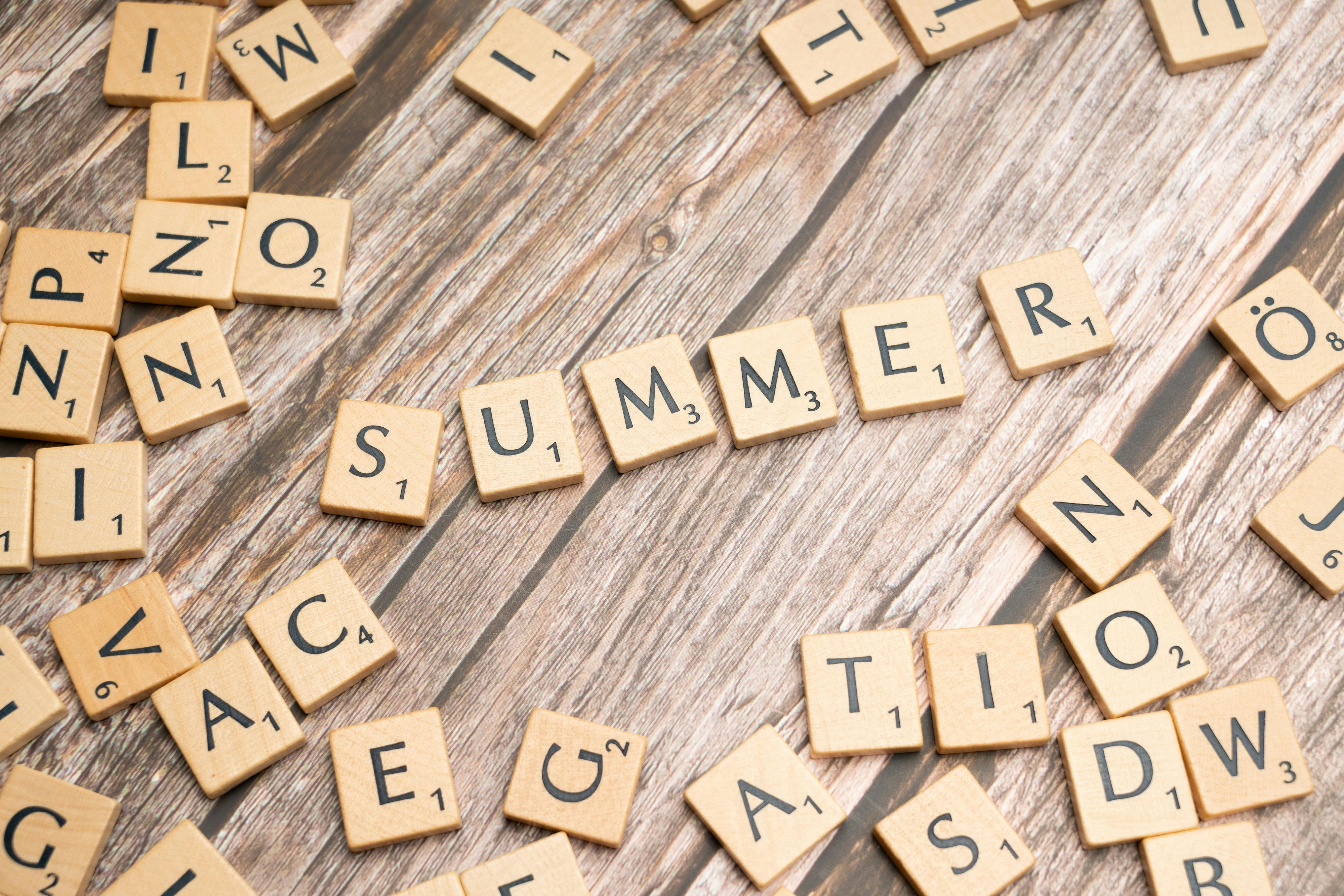 Scrabble letters spelling summer on a wooden table · Free Stock Photo