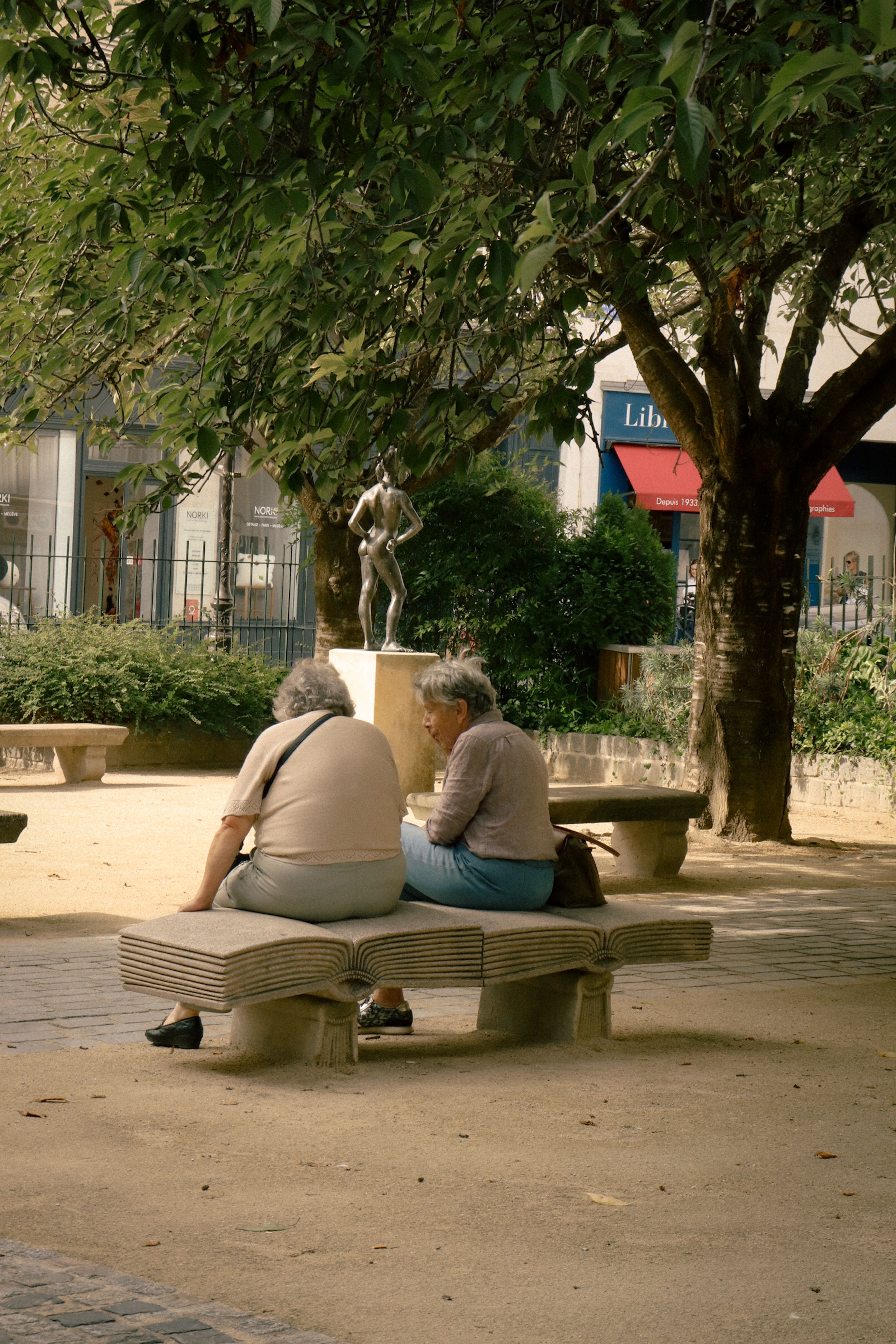 Two people sitting on a bench · Free Stock Photo