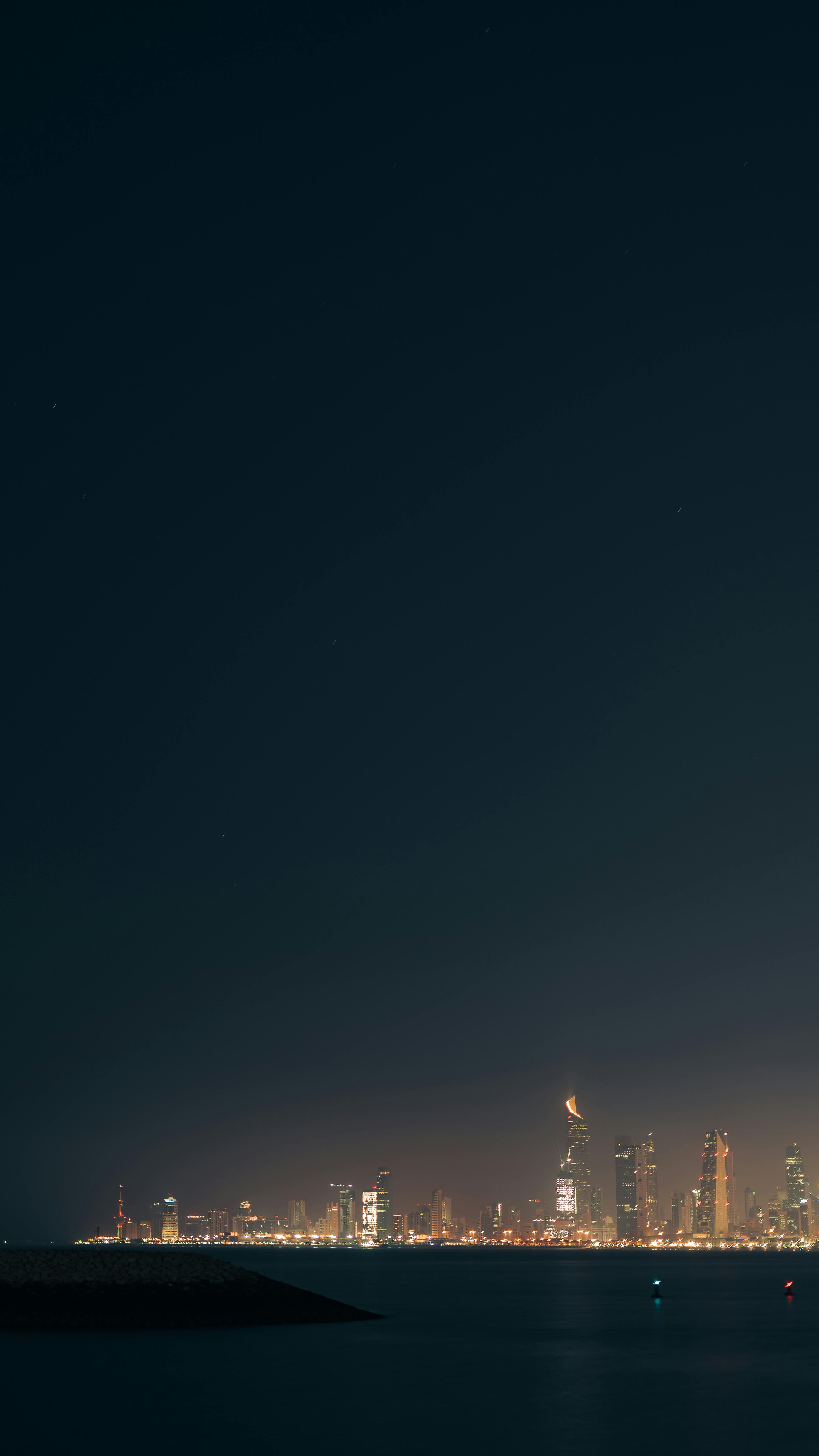 Illuminated Skyline of a City Seen from a Distance at Night · Free ...