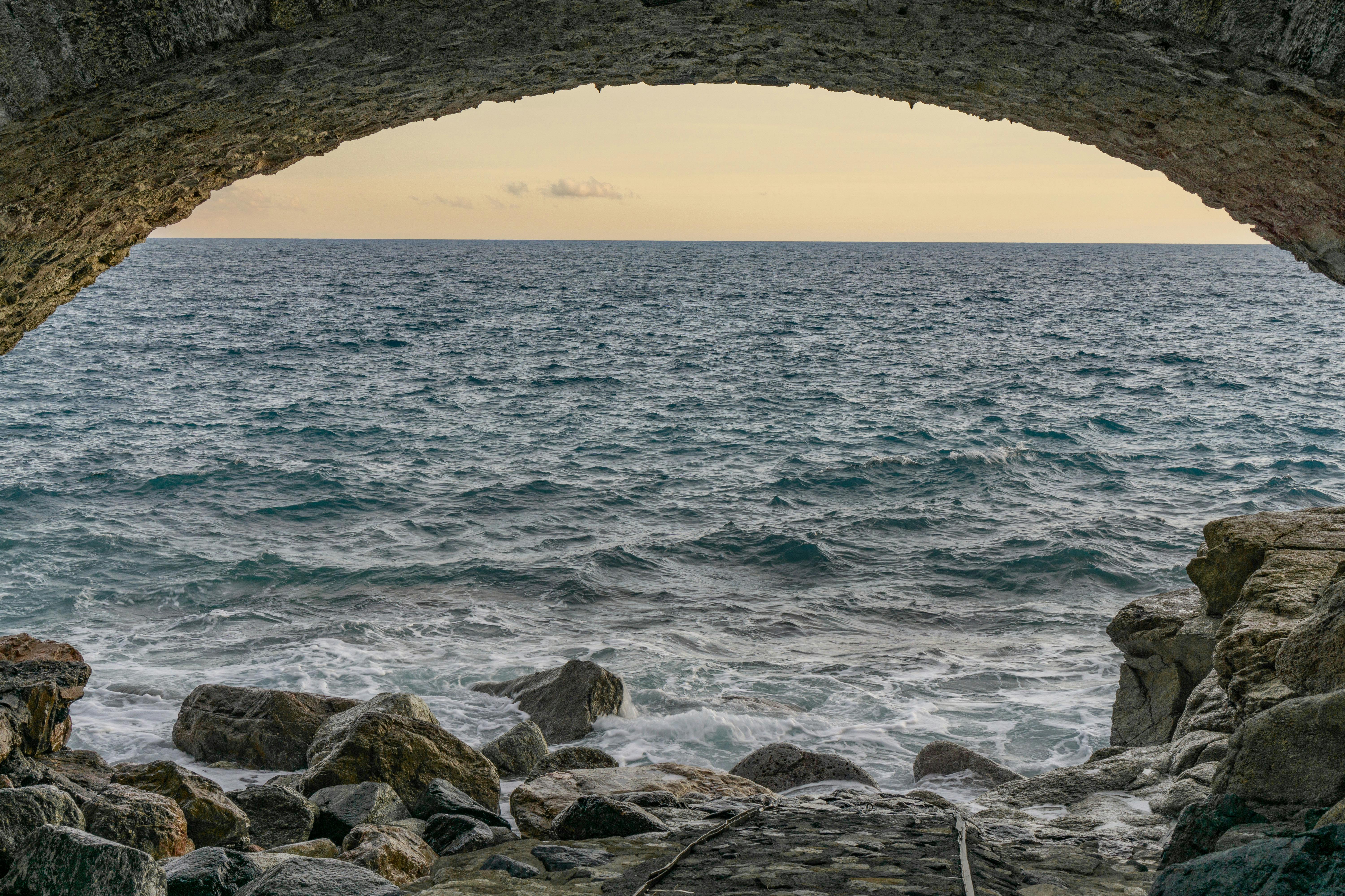 Stone Arch over Rocks on Sea Shore · Free Stock Photo