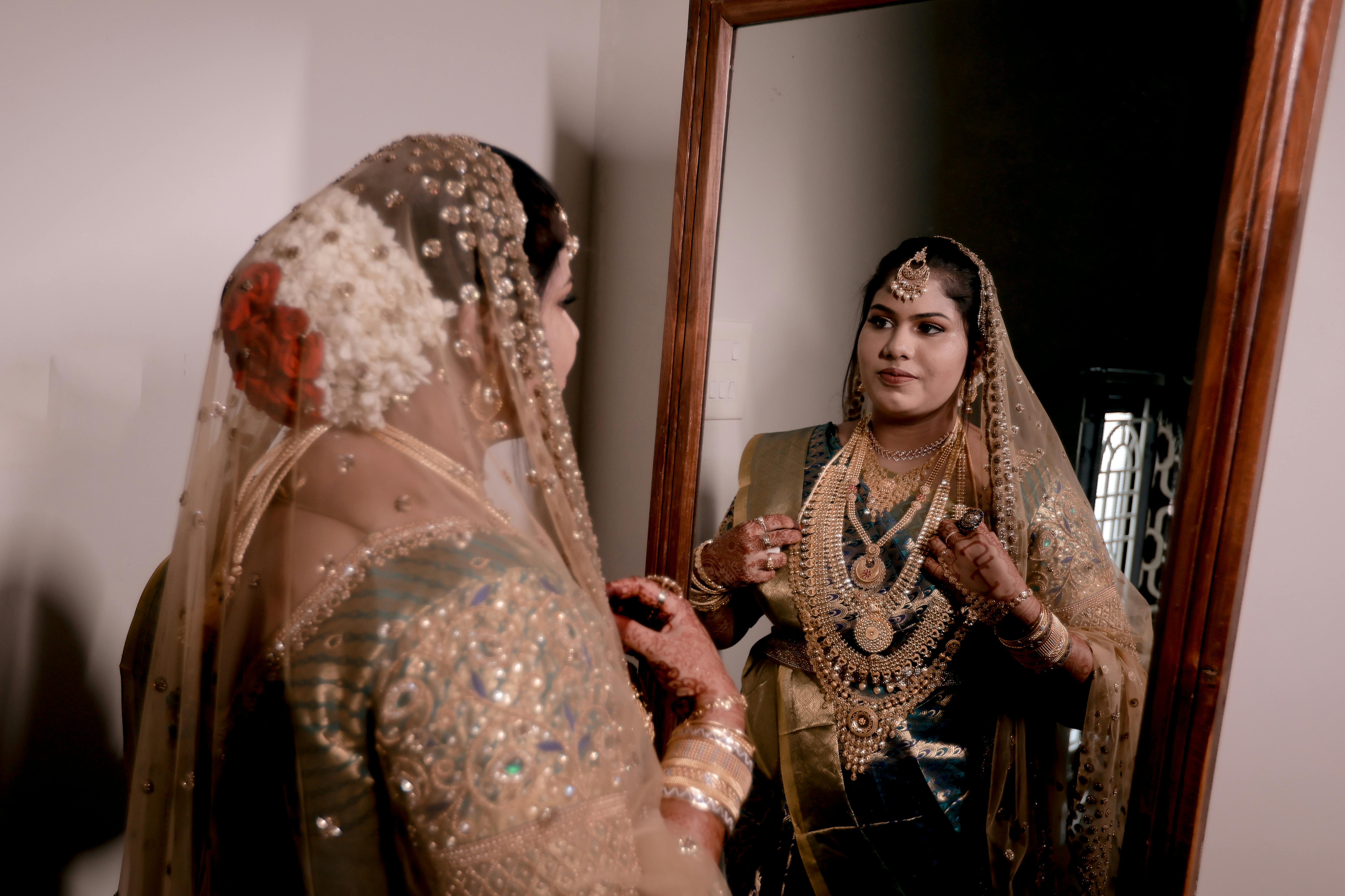 Bride in Traditional Dress Standing by Mirror · Free Stock Photo