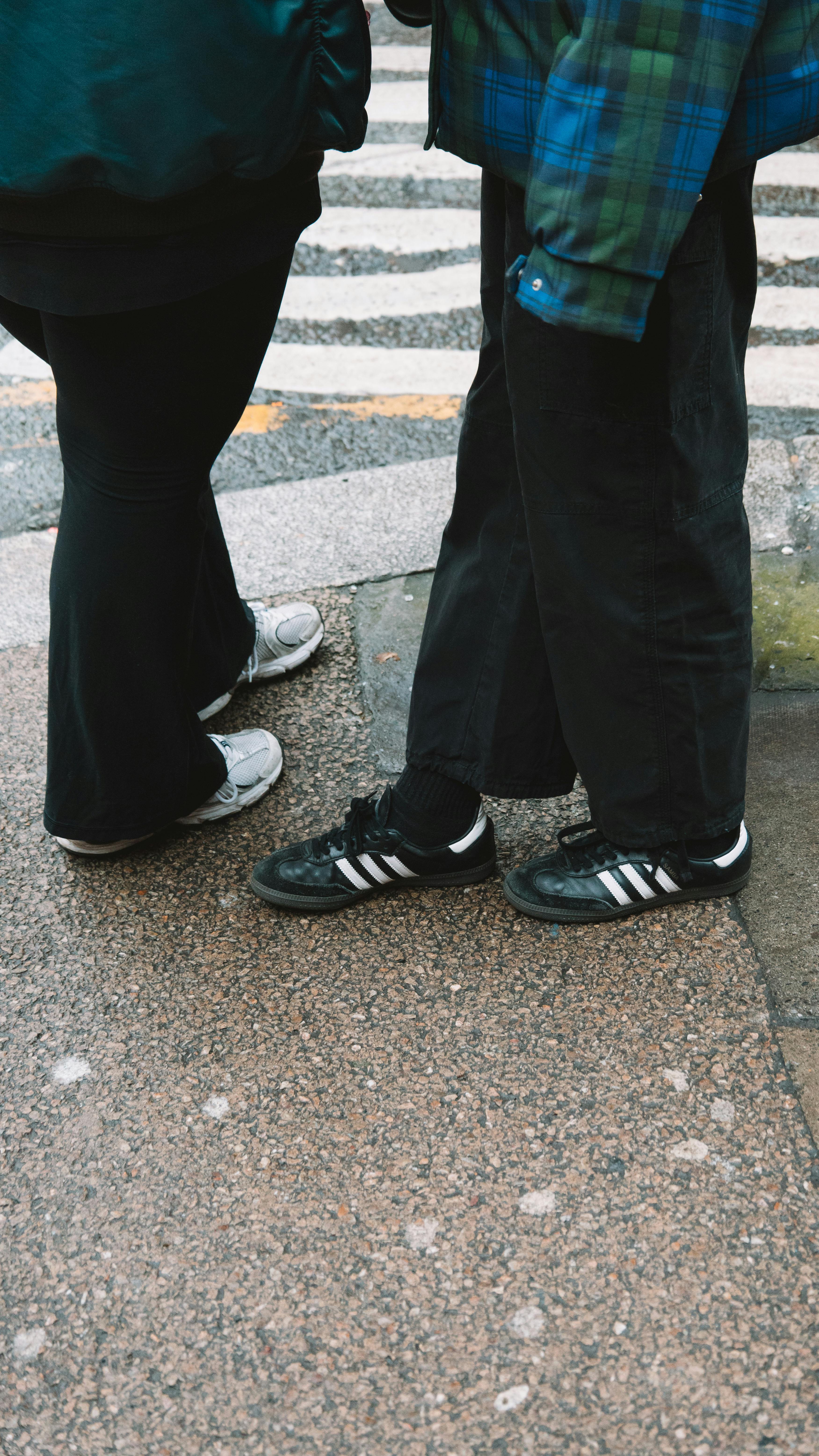 Photo Of Person Walking On Pedestrian Lane · Free Stock Photo