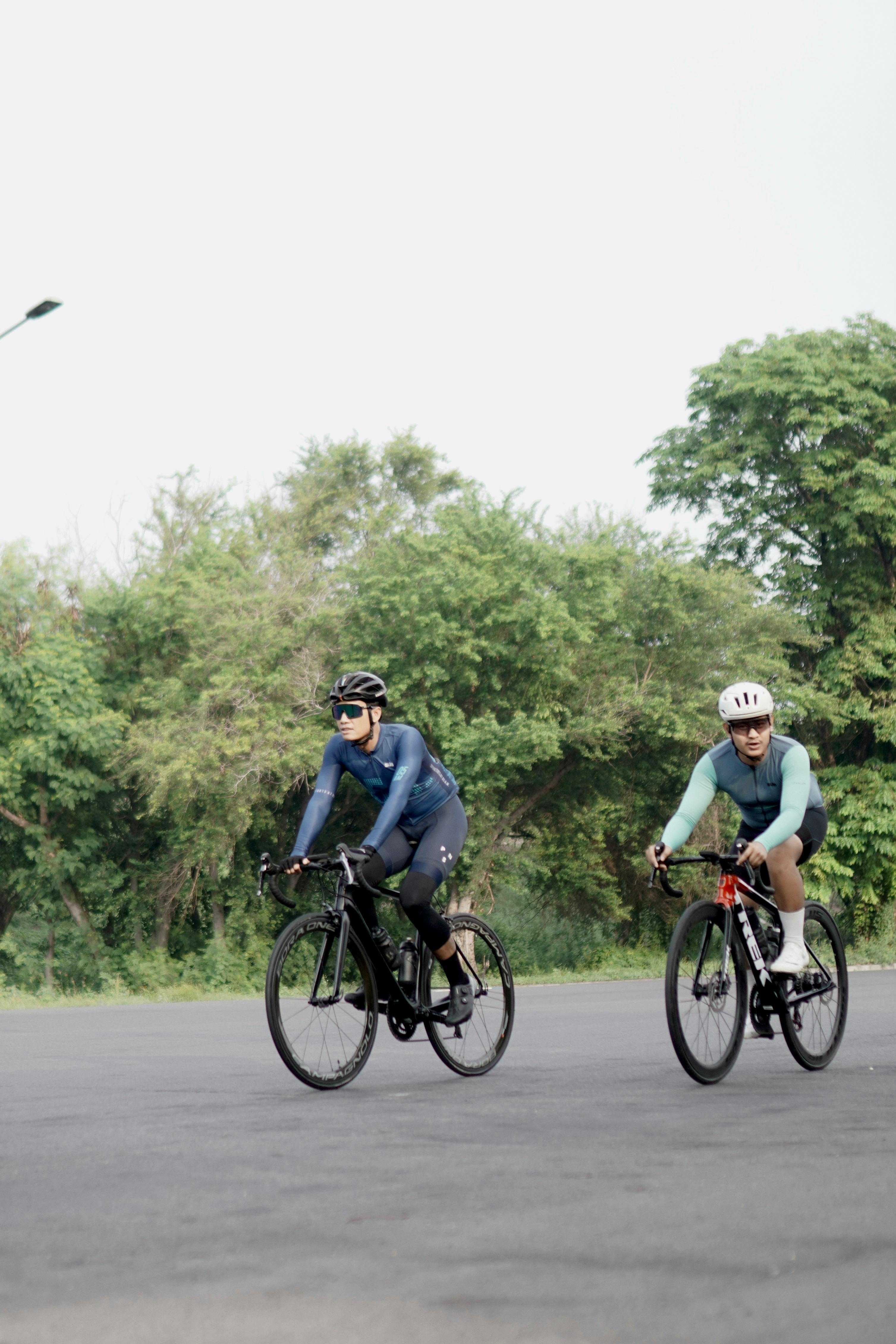 Men in Sportswear and Helmets Riding Bicycles on a Street · Free Stock ...