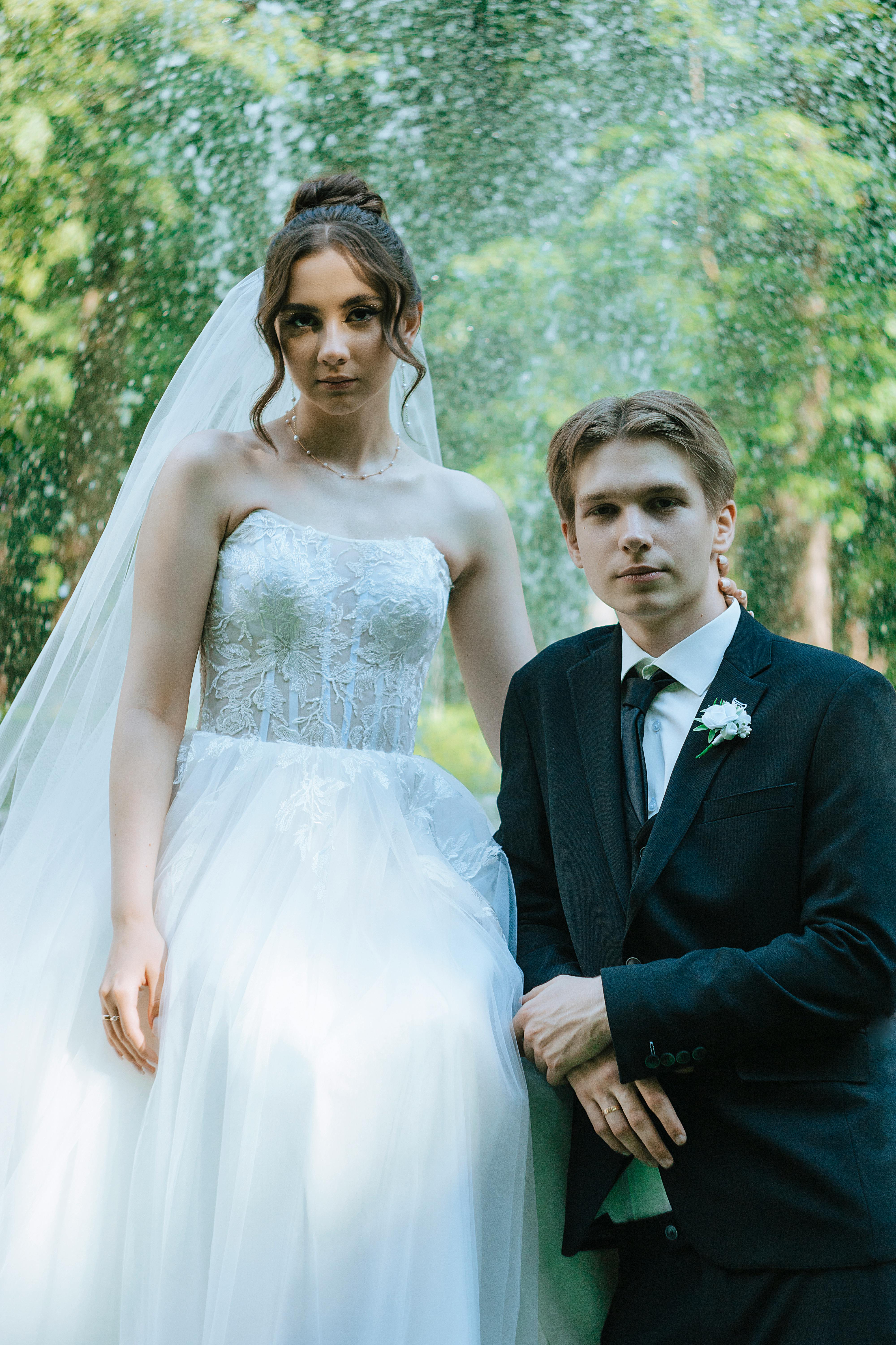 Young Bride and Groom Standing Outside · Free Stock Photo