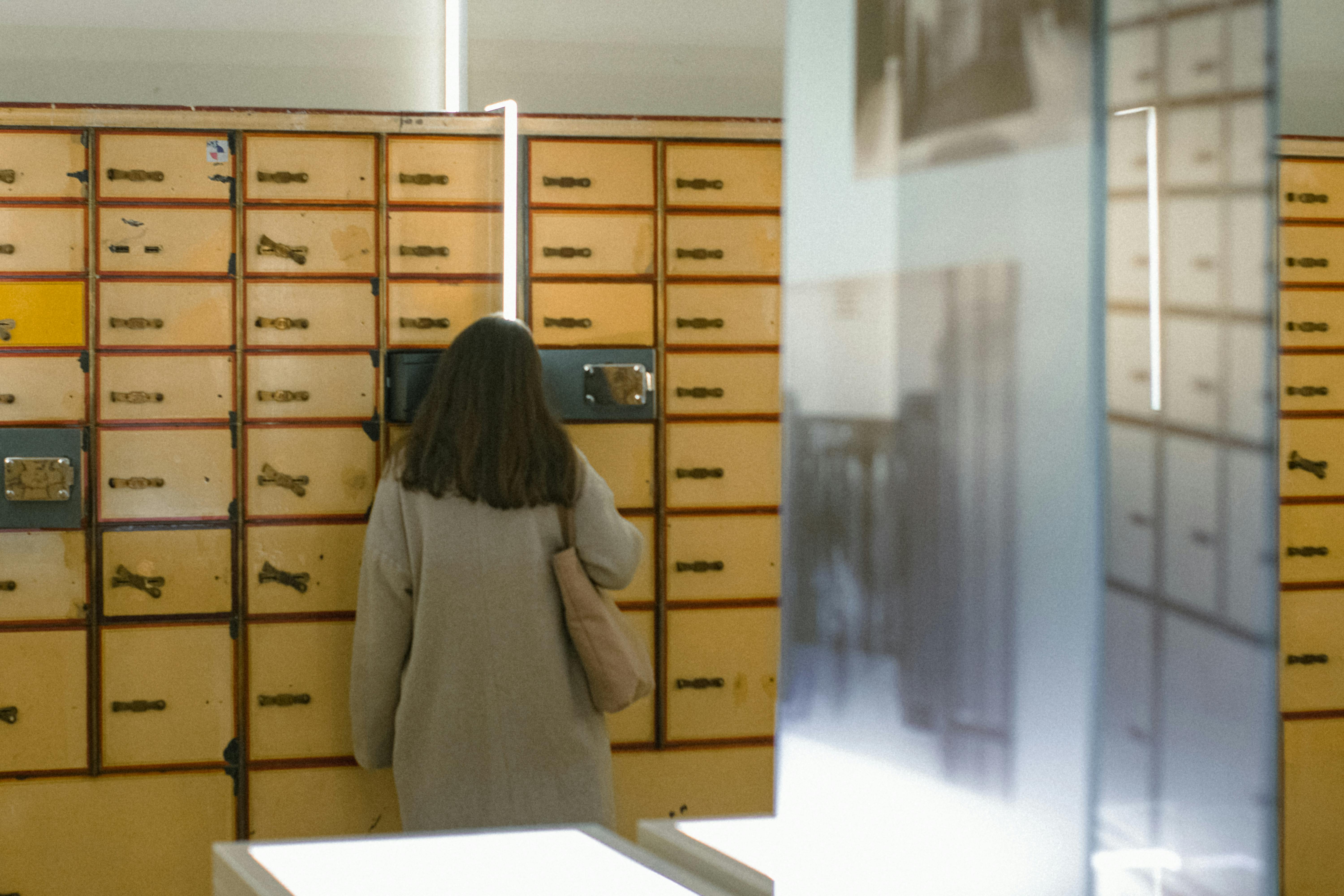 Back View of Woman Standing by Mailboxes · Free Stock Photo