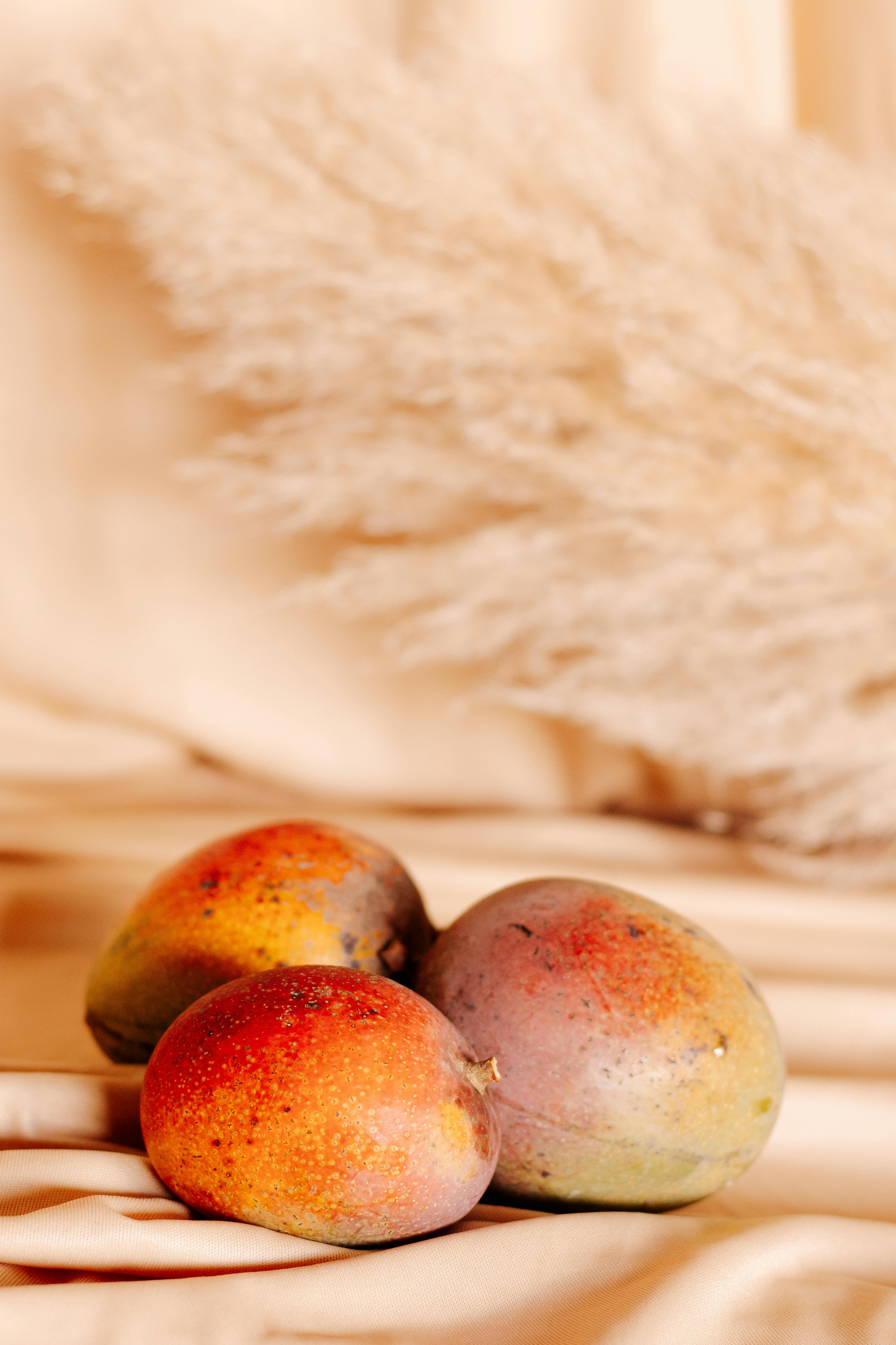 A Close-Up Shot of a Mango on a Cloth · Free Stock Photo